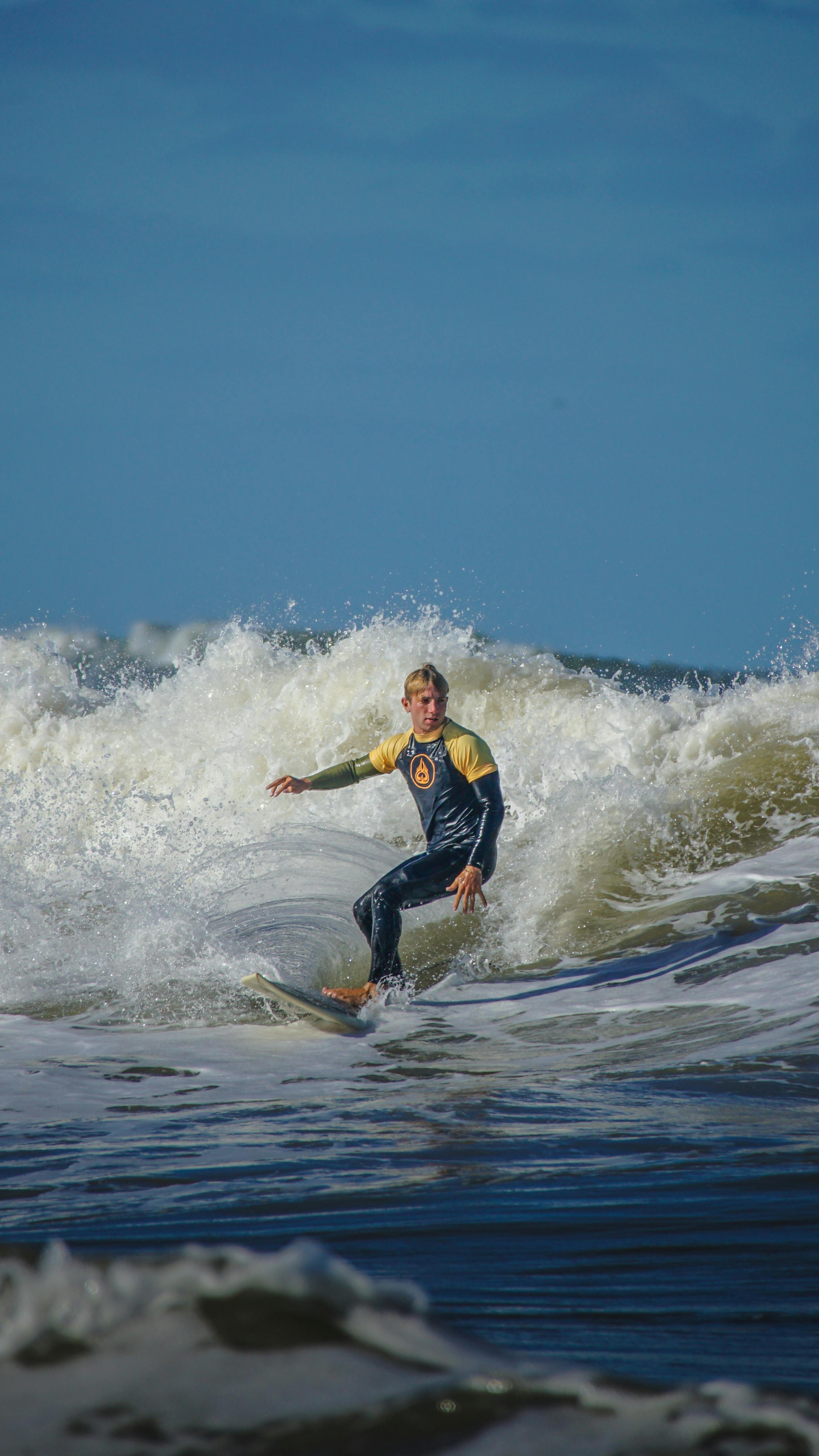 Man Surfing on Sea Shore · Free Stock Photo