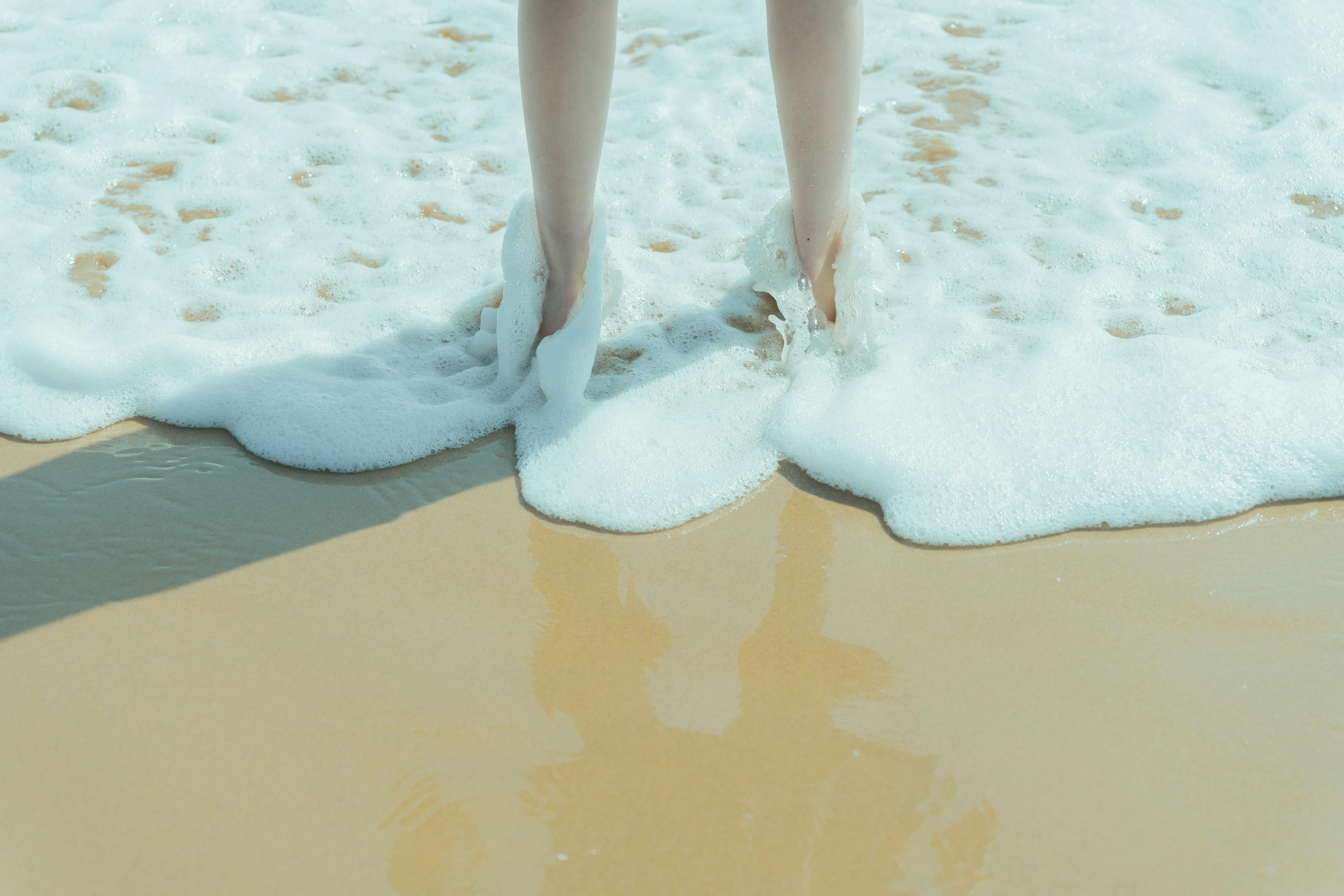 Close-up of Person Standing Ankles Deep in the Sea · Free Stock Photo