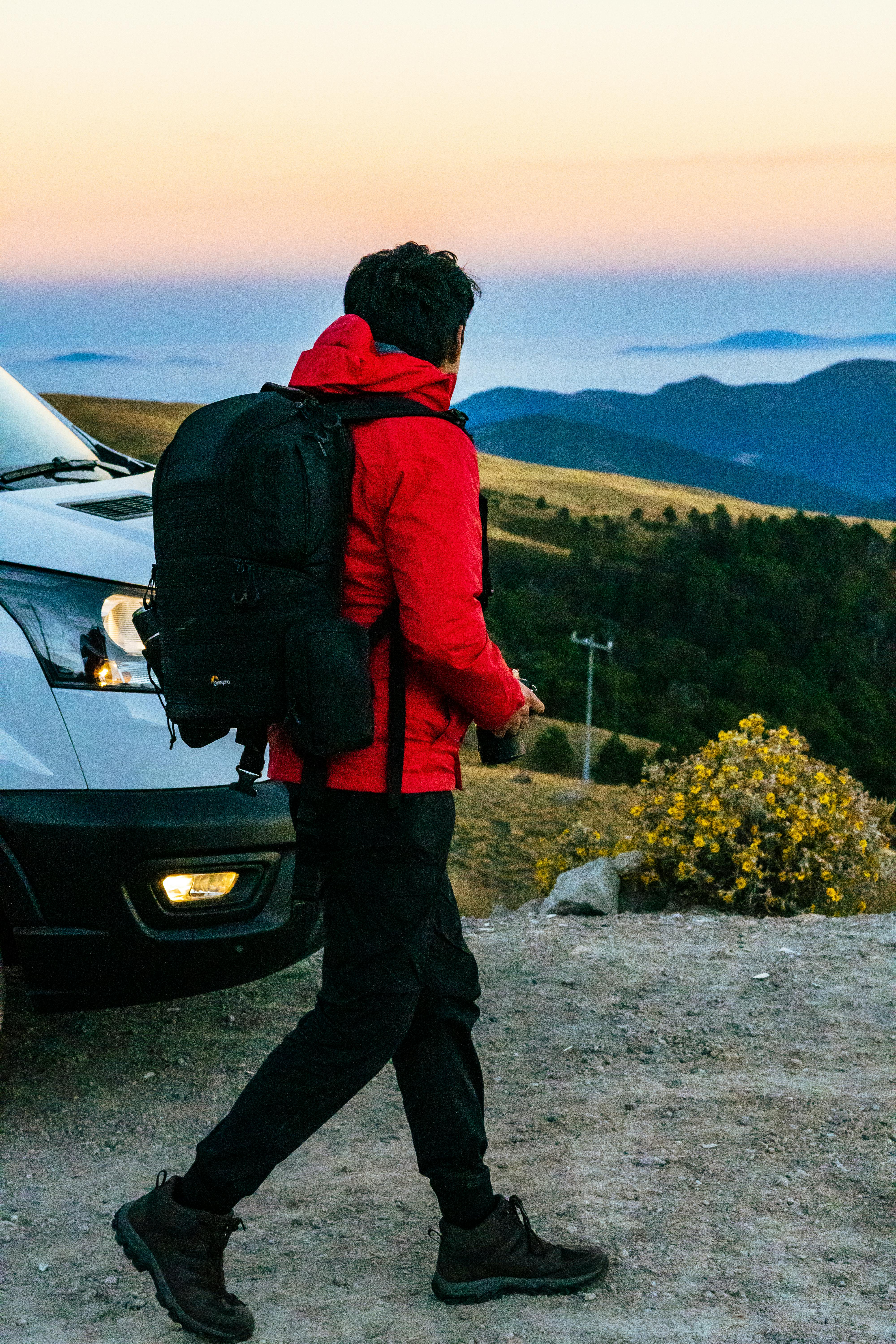 Person in Jacket and with Backpack at Sunset · Free Stock Photo