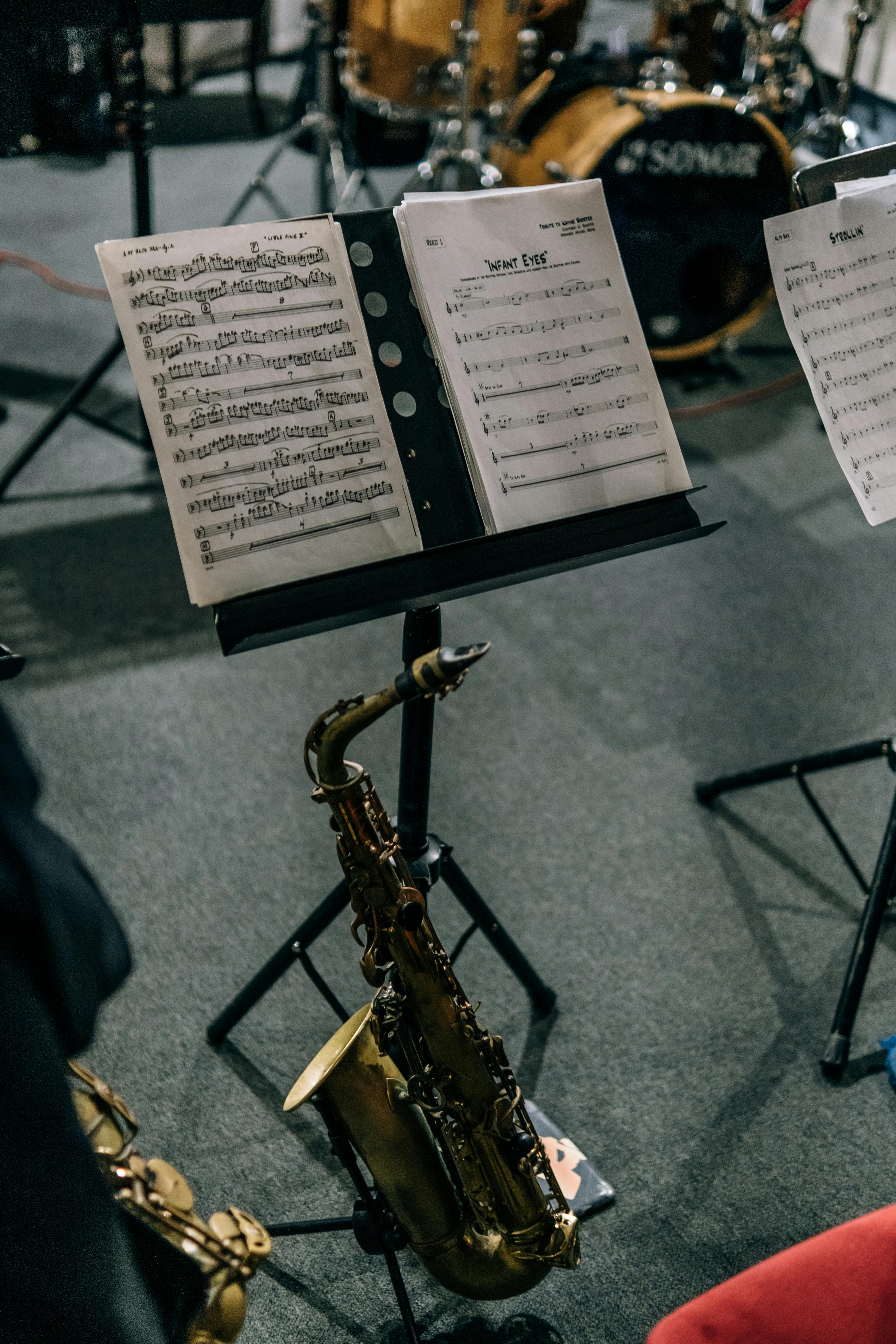 Brass Saxophone on Gray Table Near Black Bag · Free Stock Photo
