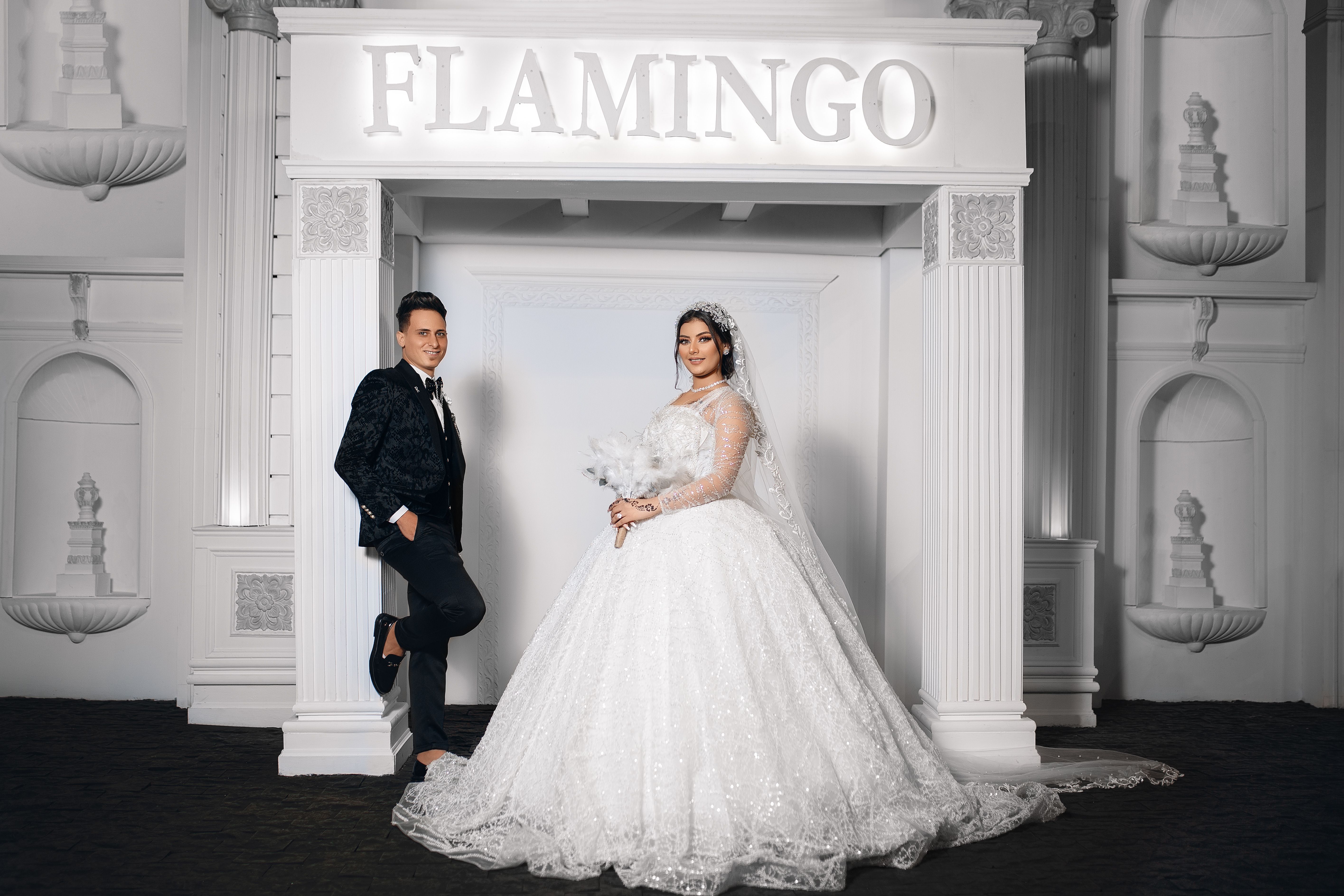 Groom in Suit and Bride in White Dress Posing at Wedding · Free Stock Photo