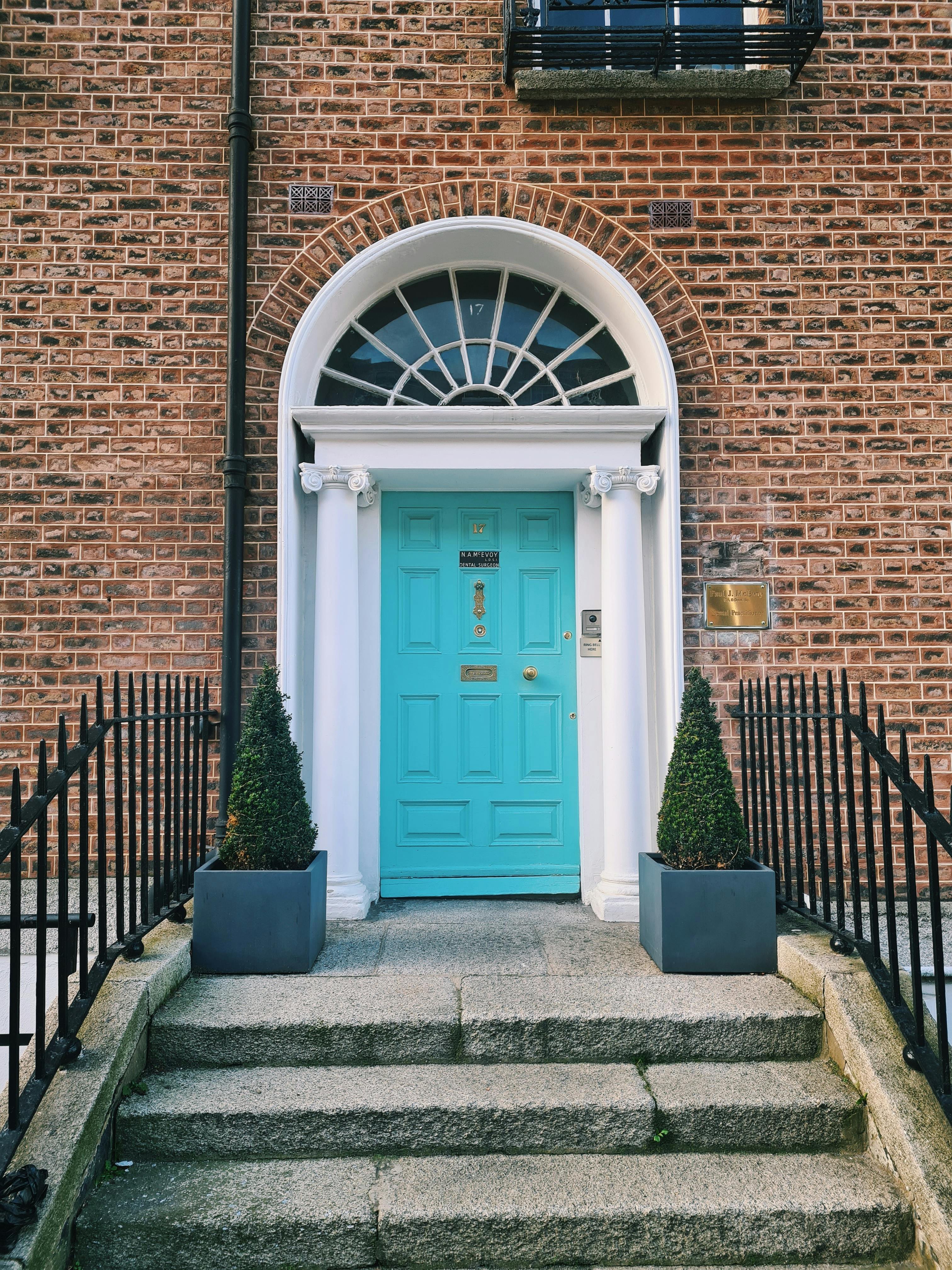 Building with Brick Wall and Blue Door · Free Stock Photo
