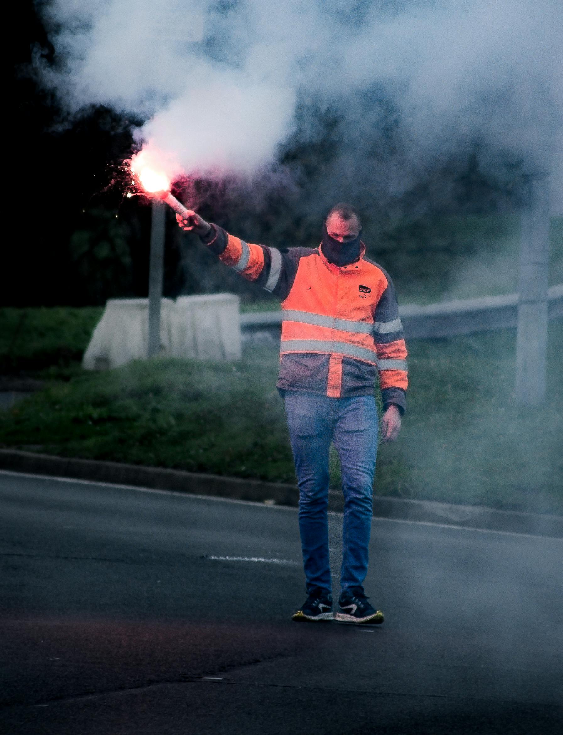 Man Protesting with Flare on Road · Free Stock Photo