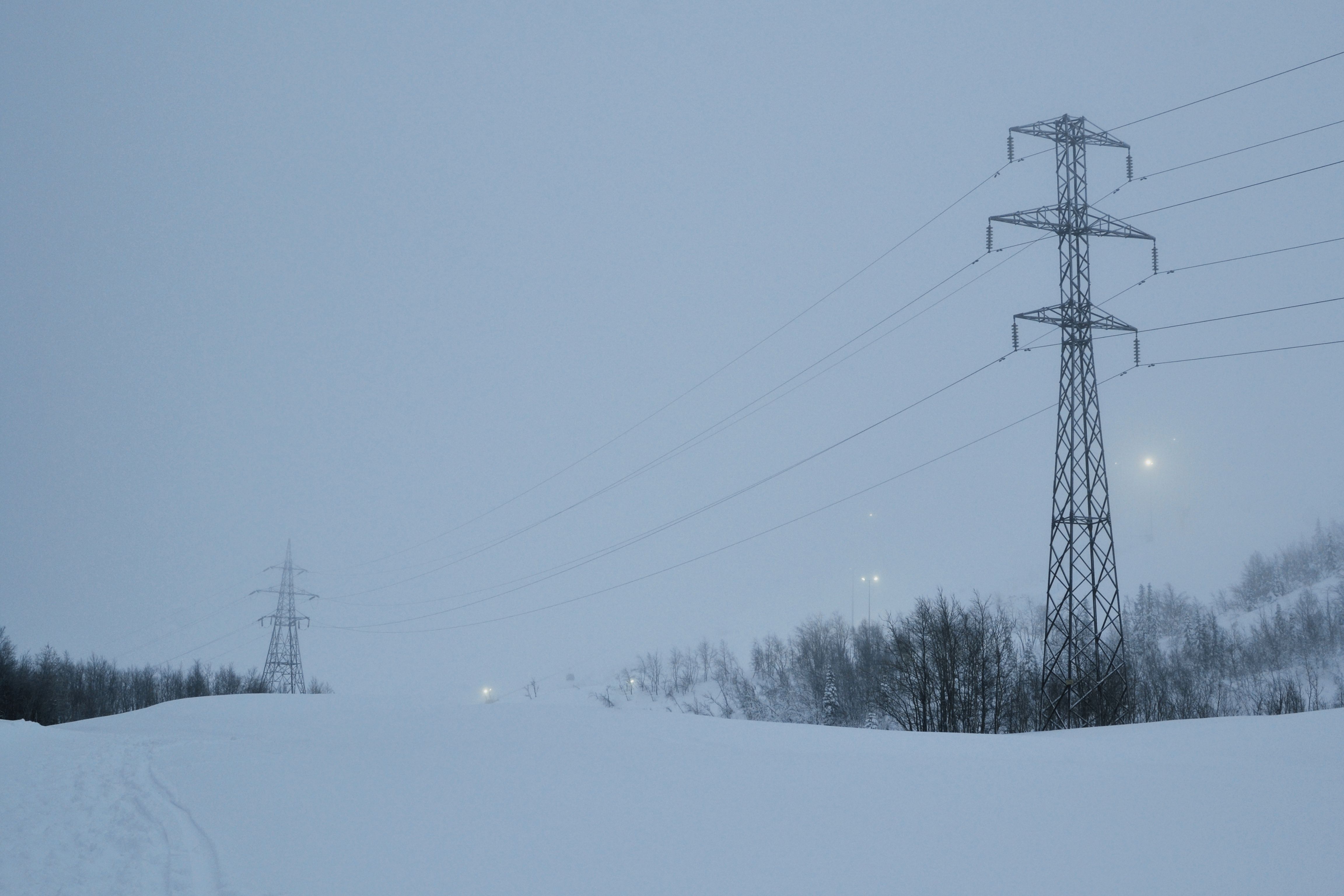 Transmission Towers on Water near City · Free Stock Photo
