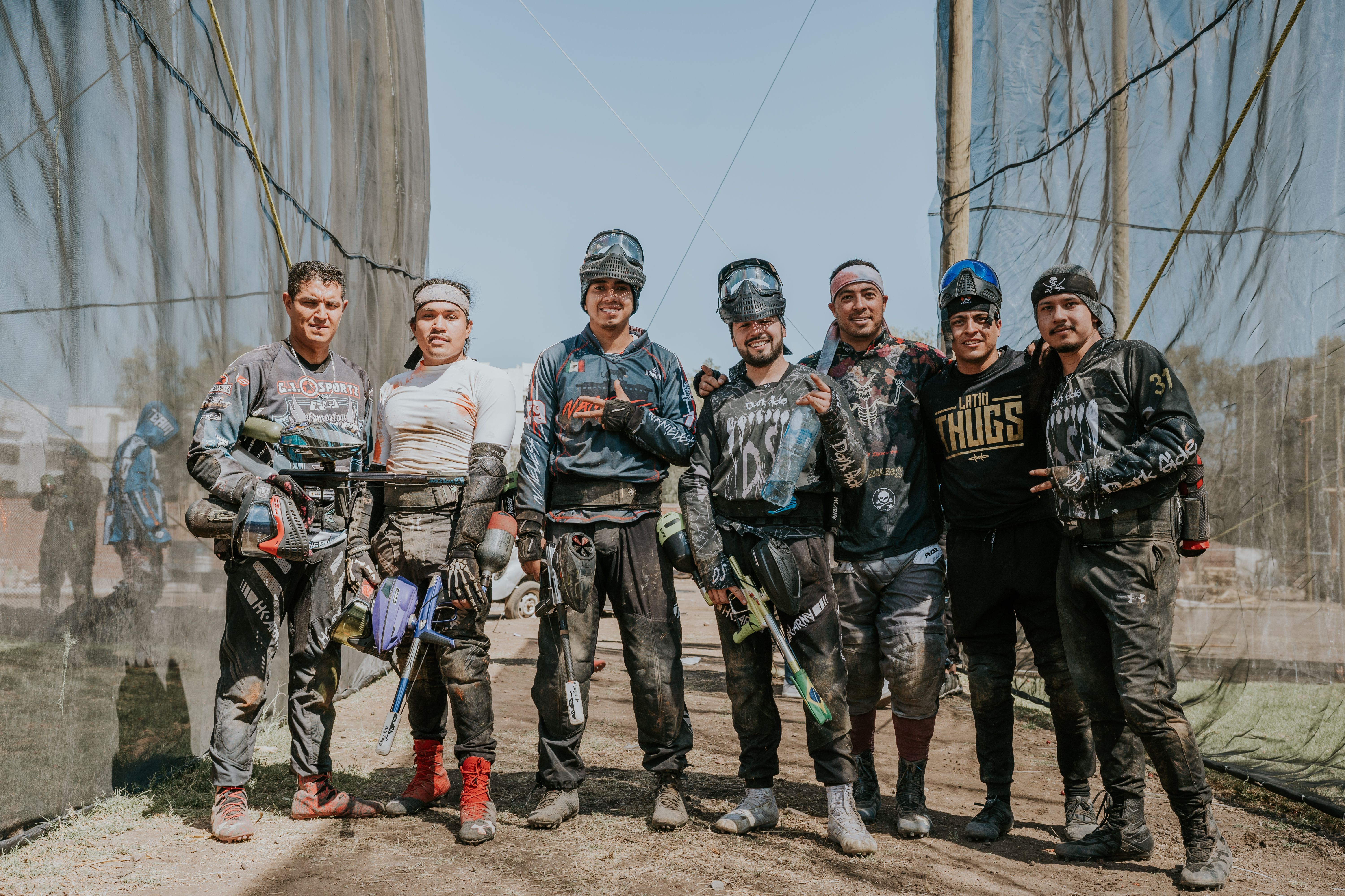 A group of people in paintball gear posing for a photo · Free Stock Photo