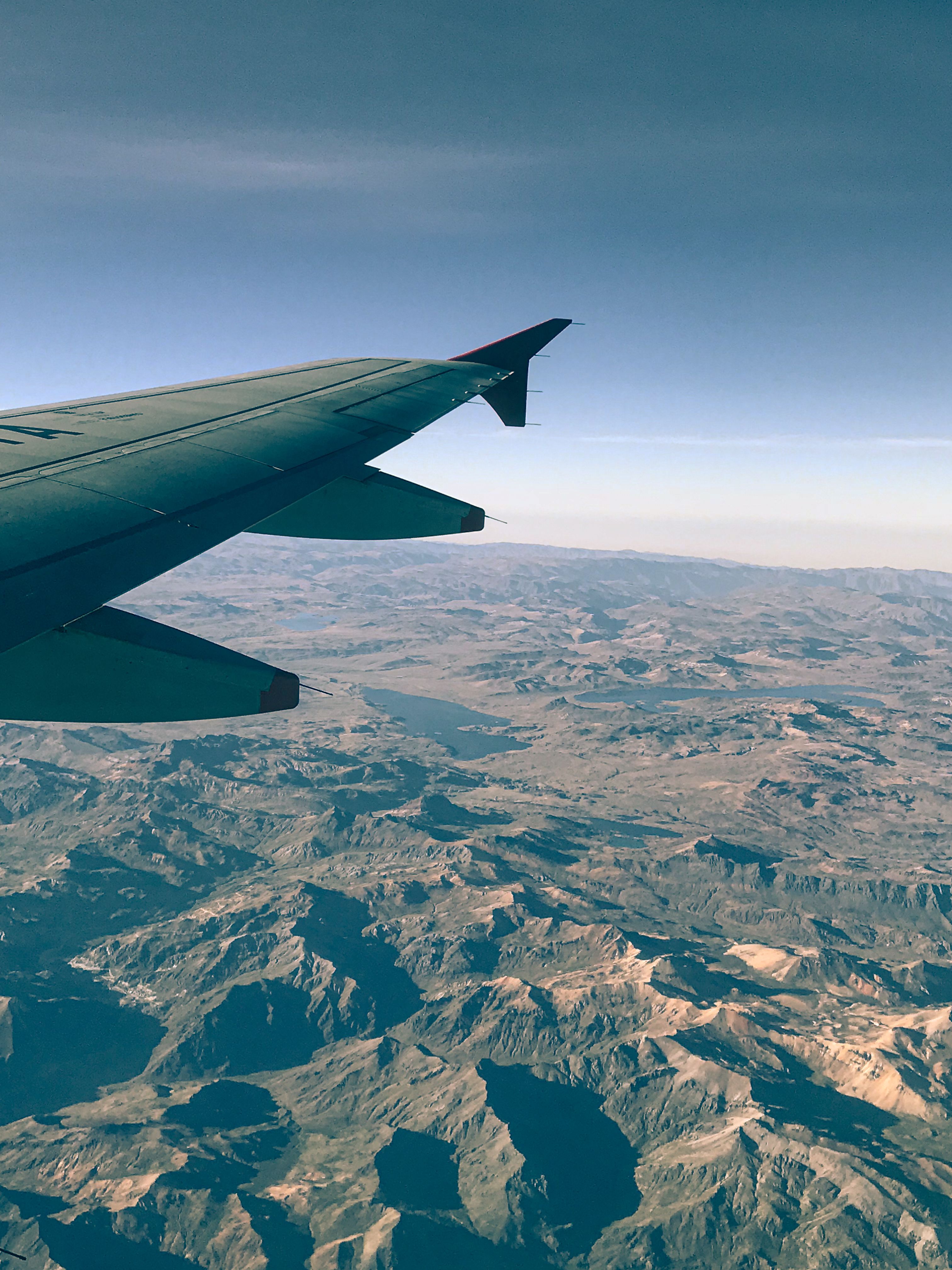 Mountains behind Flying Airplane Wing · Free Stock Photo