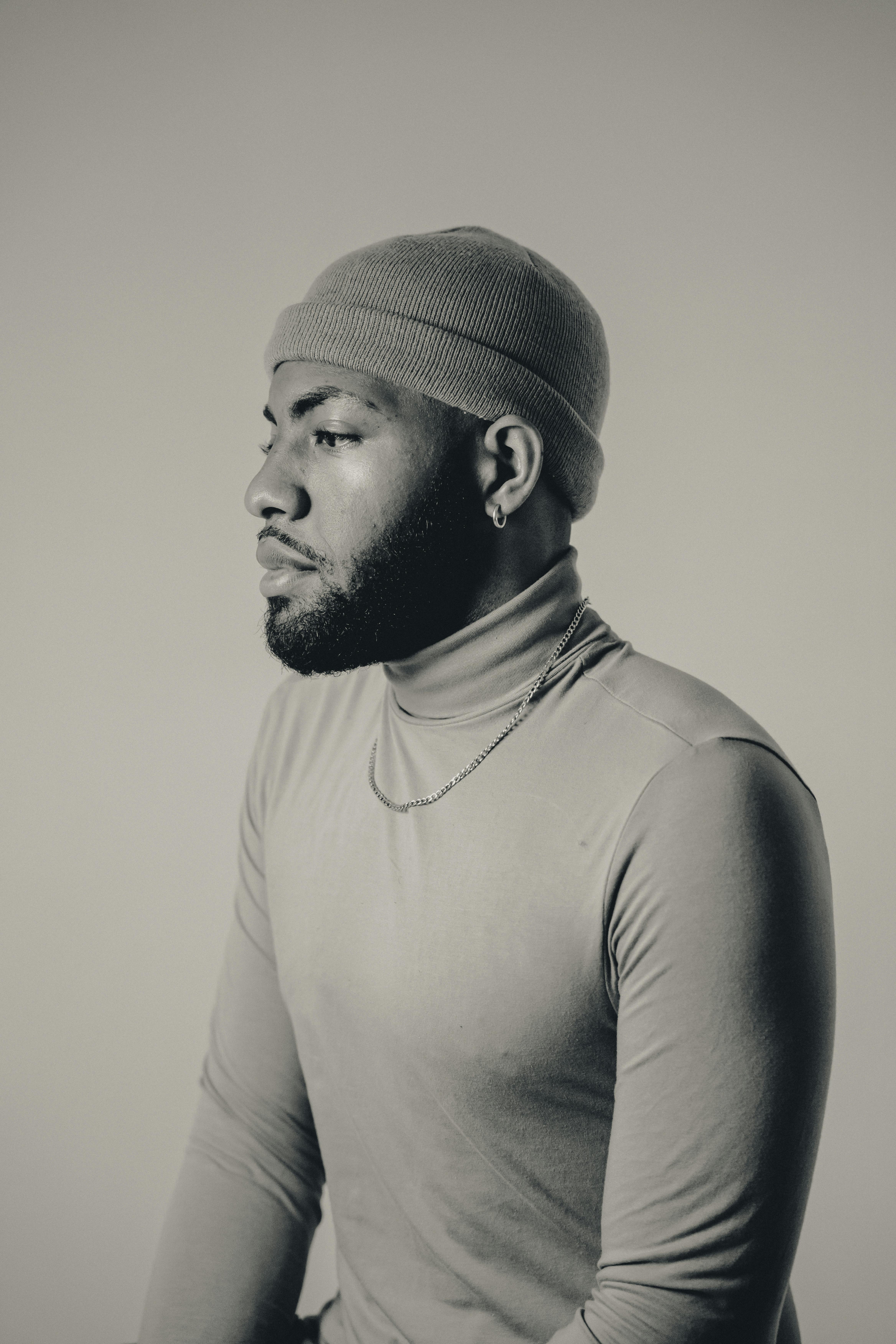 Grayscale Portrait Photo of Man Wearing Holding a Camera · Free Stock Photo