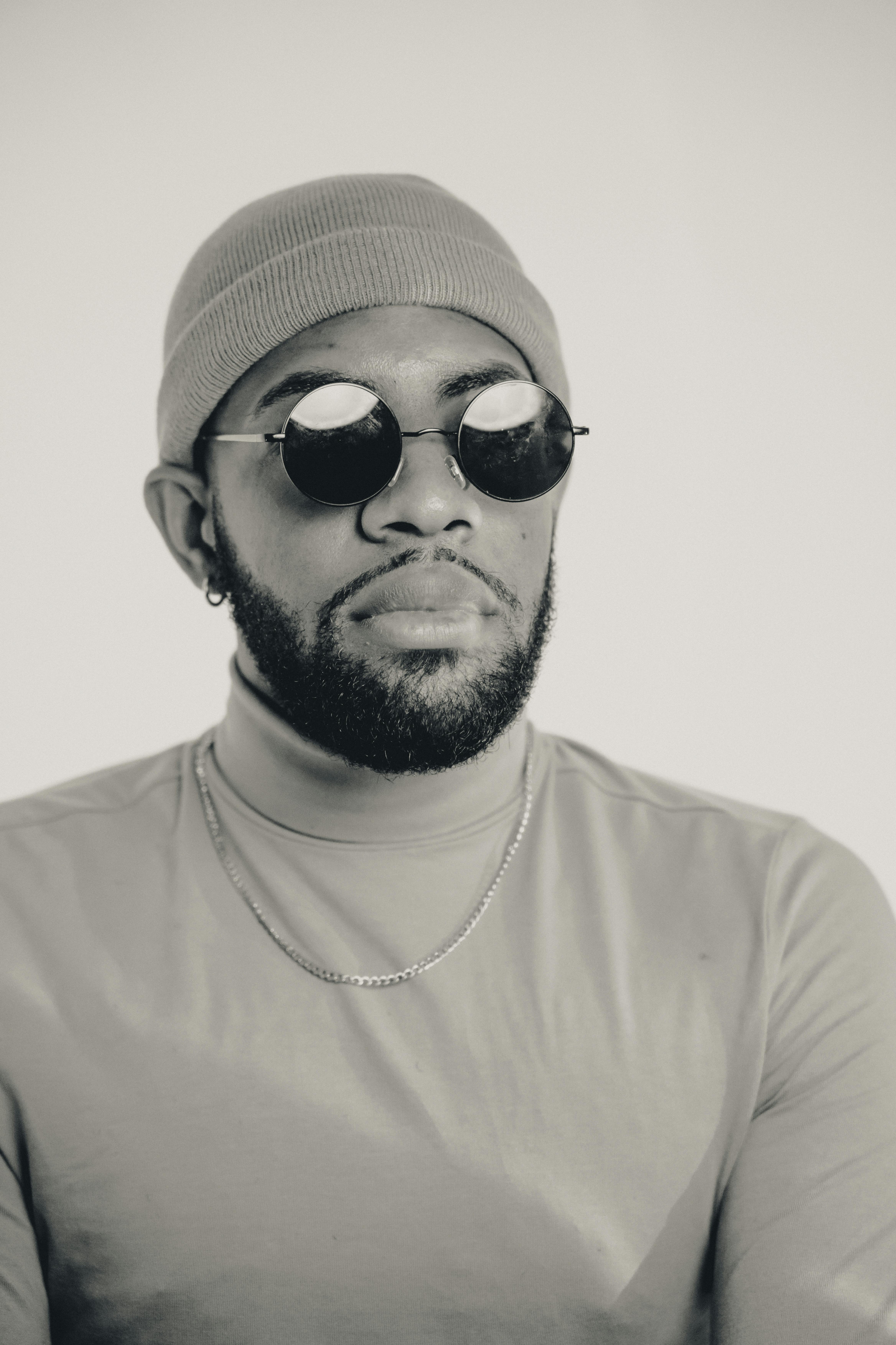 Grayscale Portrait Photo of Man Wearing Holding a Camera · Free Stock Photo