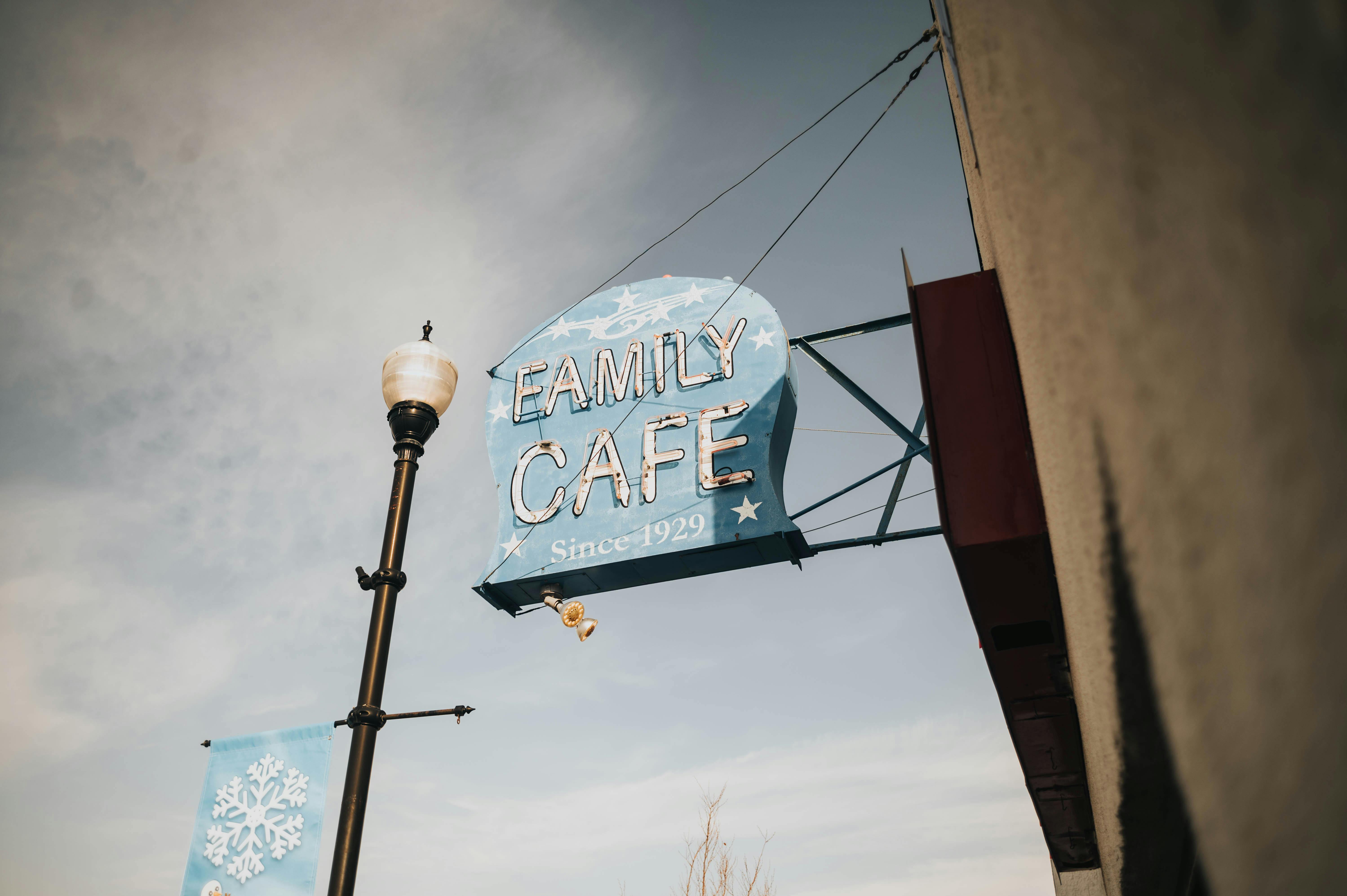 Family Cafe Logo near Building Wall · Free Stock Photo