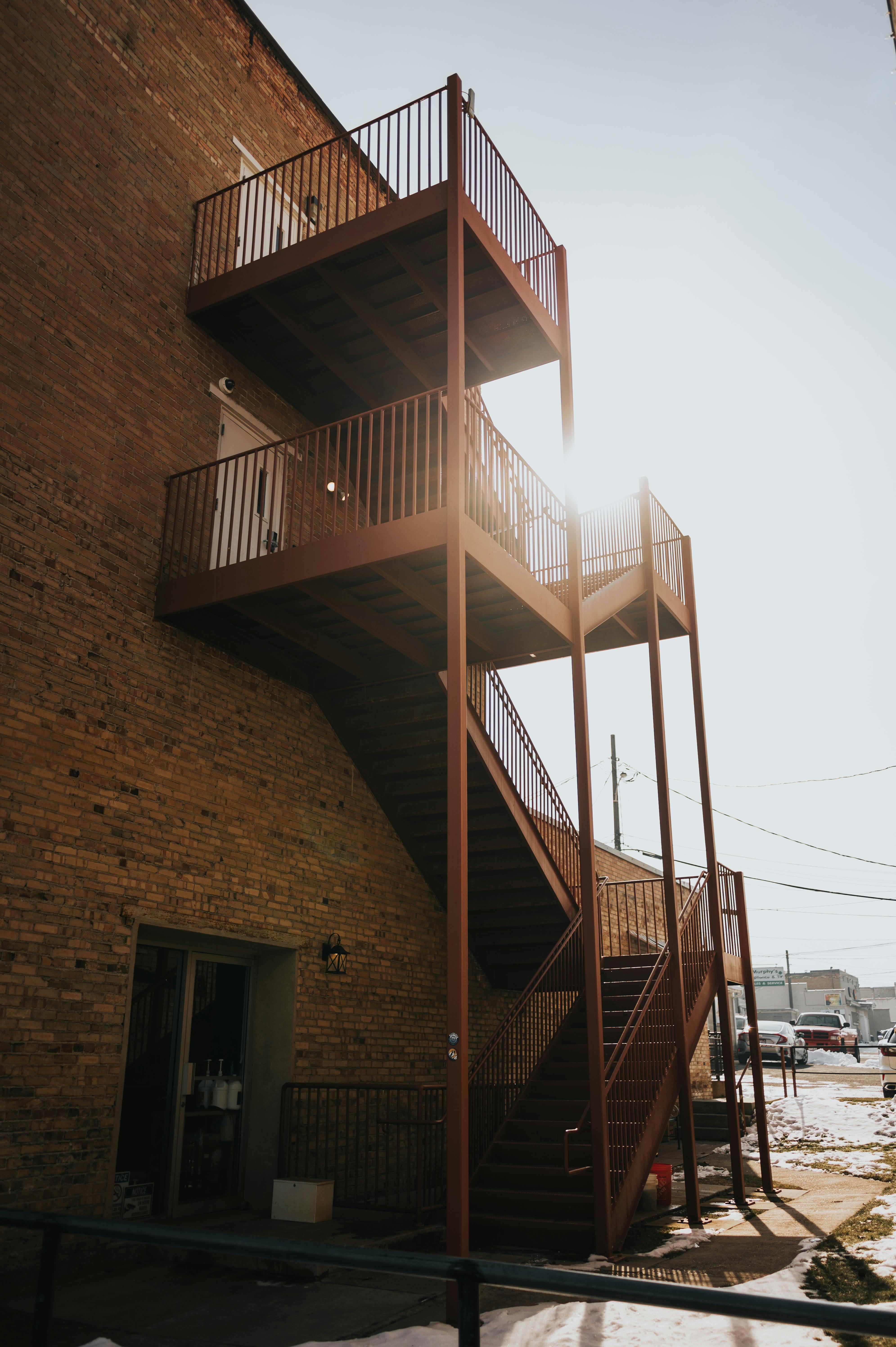 A building with stairs and a railing on the side · Free Stock Photo