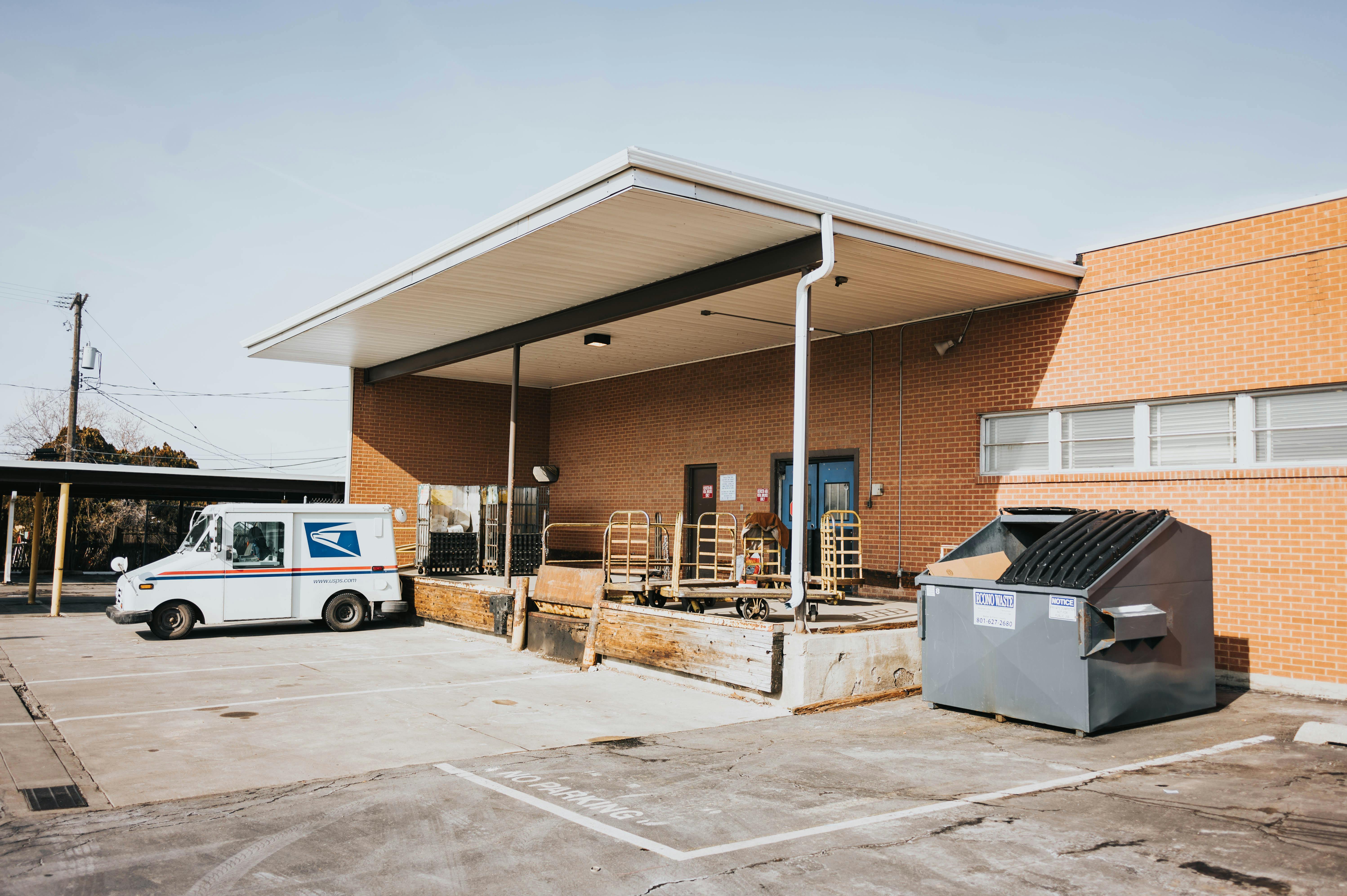 View of a Parking Lot and a Trash Bin at the Back of a Building · Free ...
