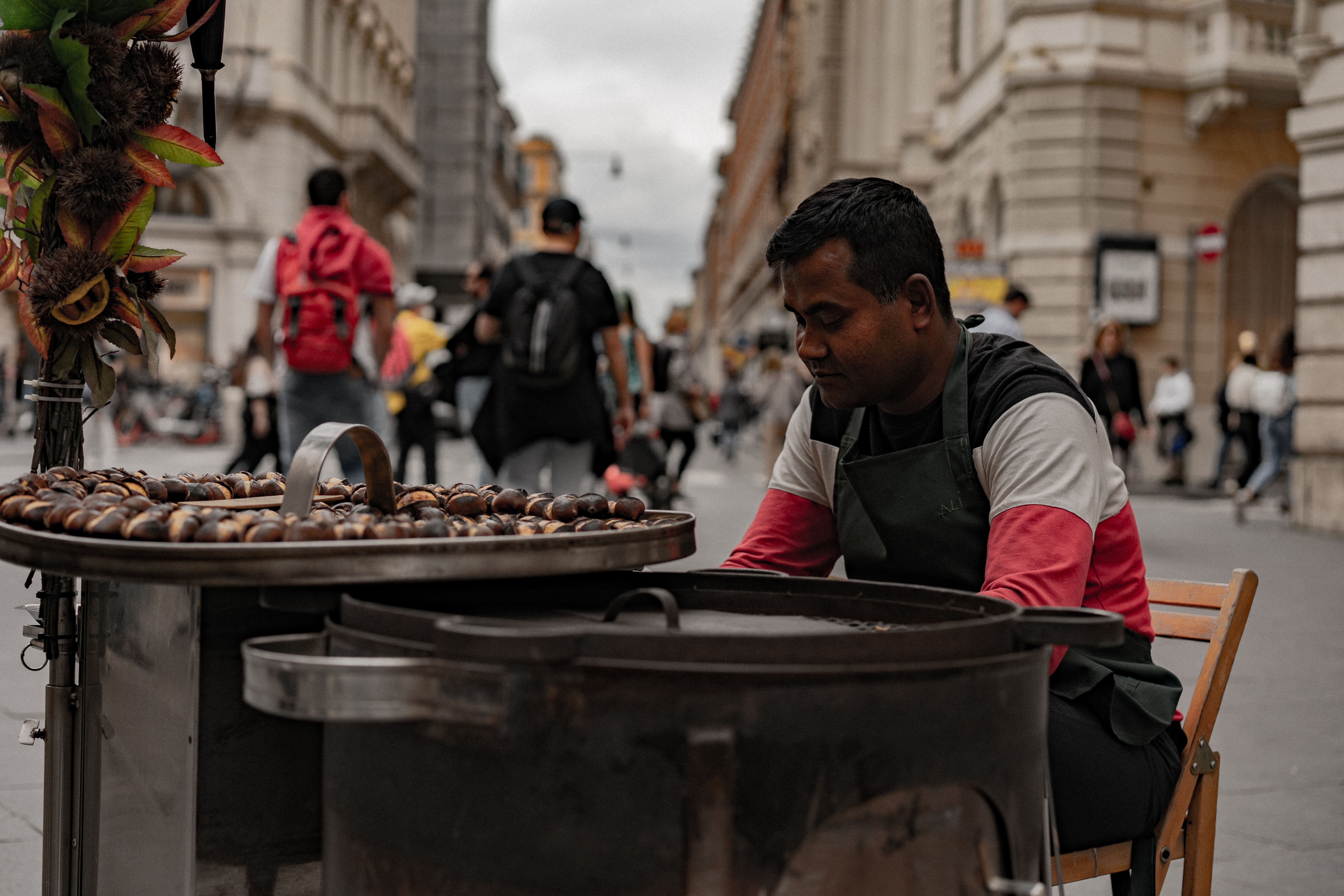 A Man Selling Chestnuts on a Street in City · Free Stock Photo