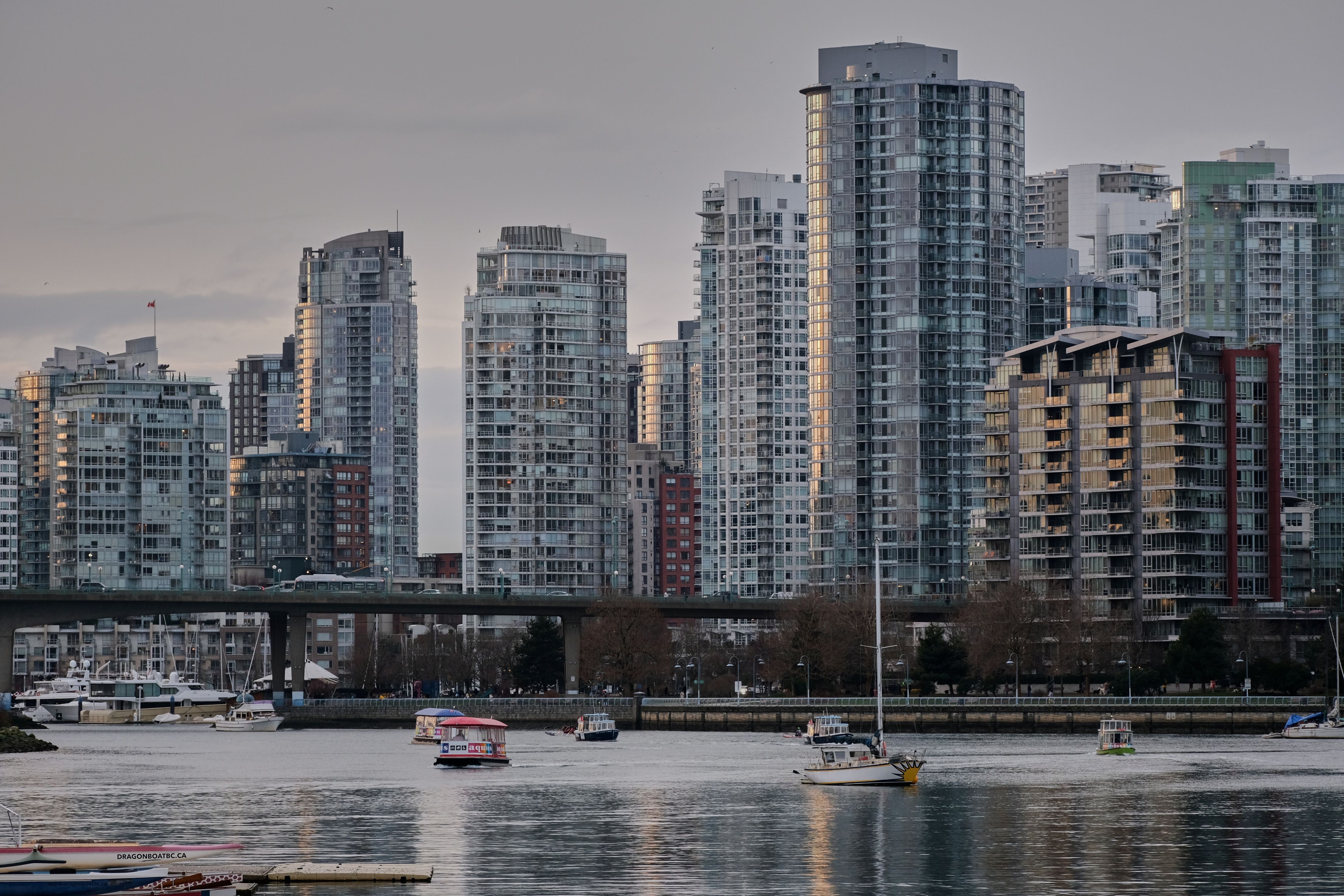 A city skyline with boats in the water and buildings · Free Stock Photo