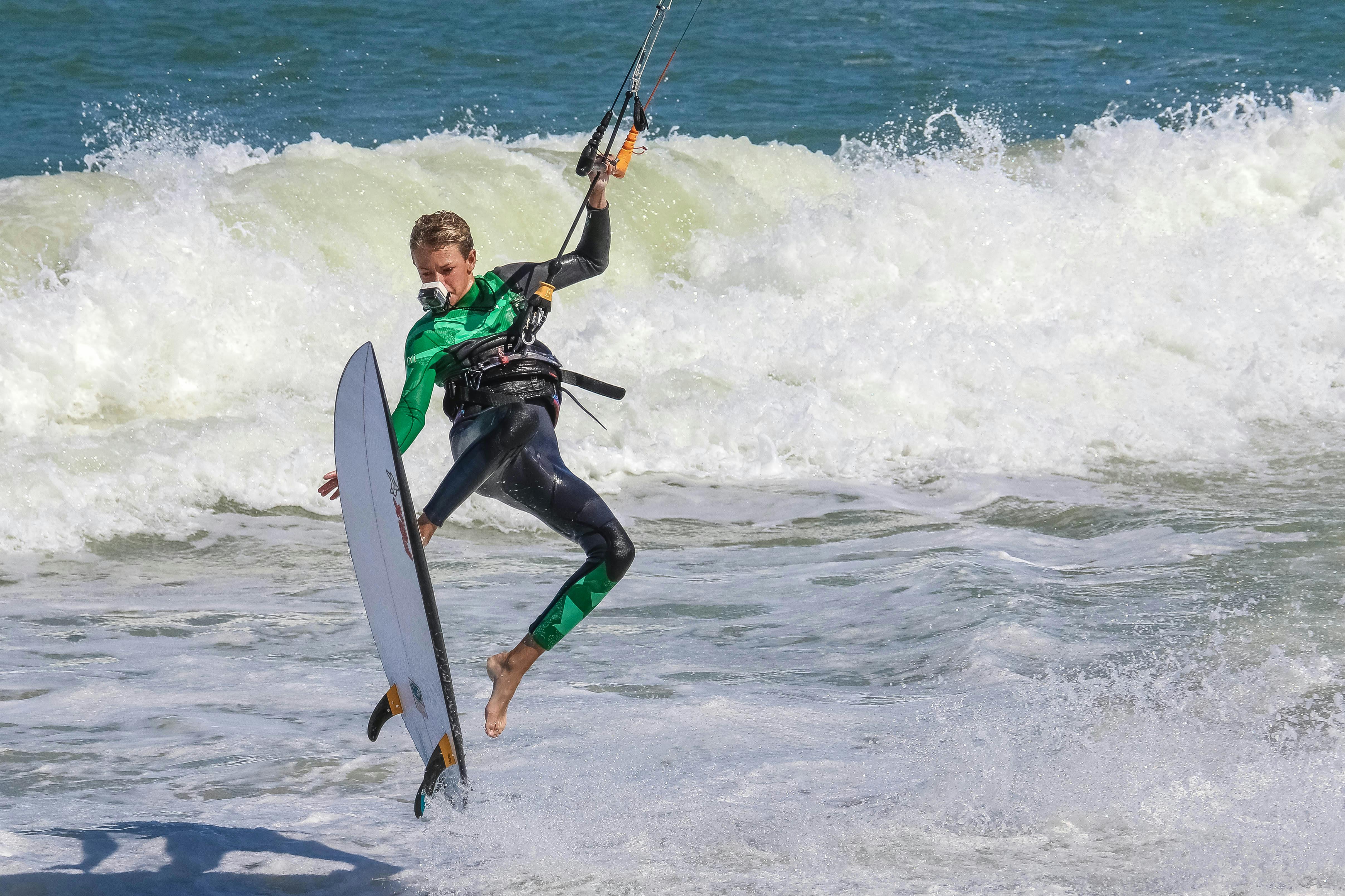 Person Riding Surf Board · Free Stock Photo