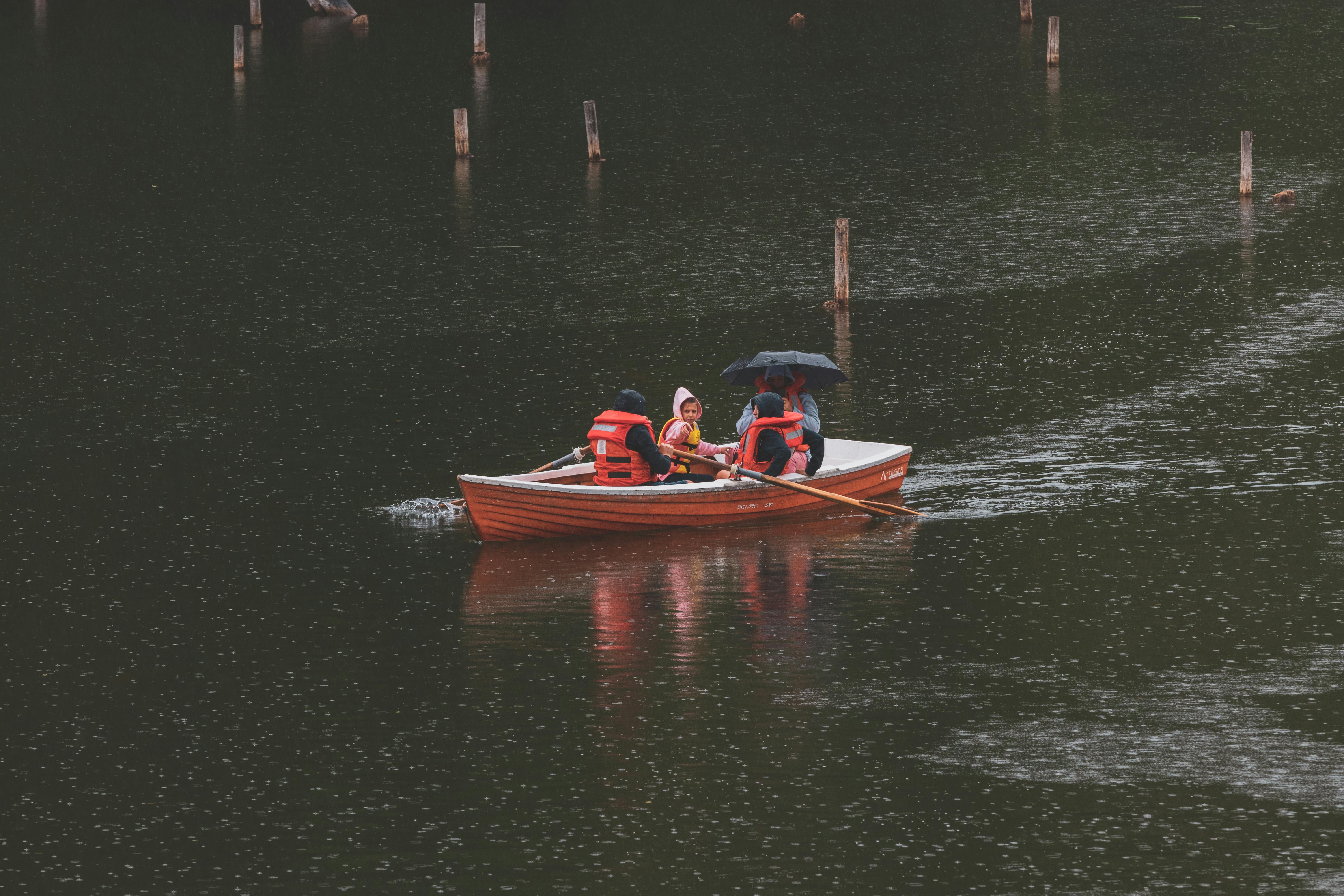 Men Rowing a Wooden Boat · Free Stock Photo