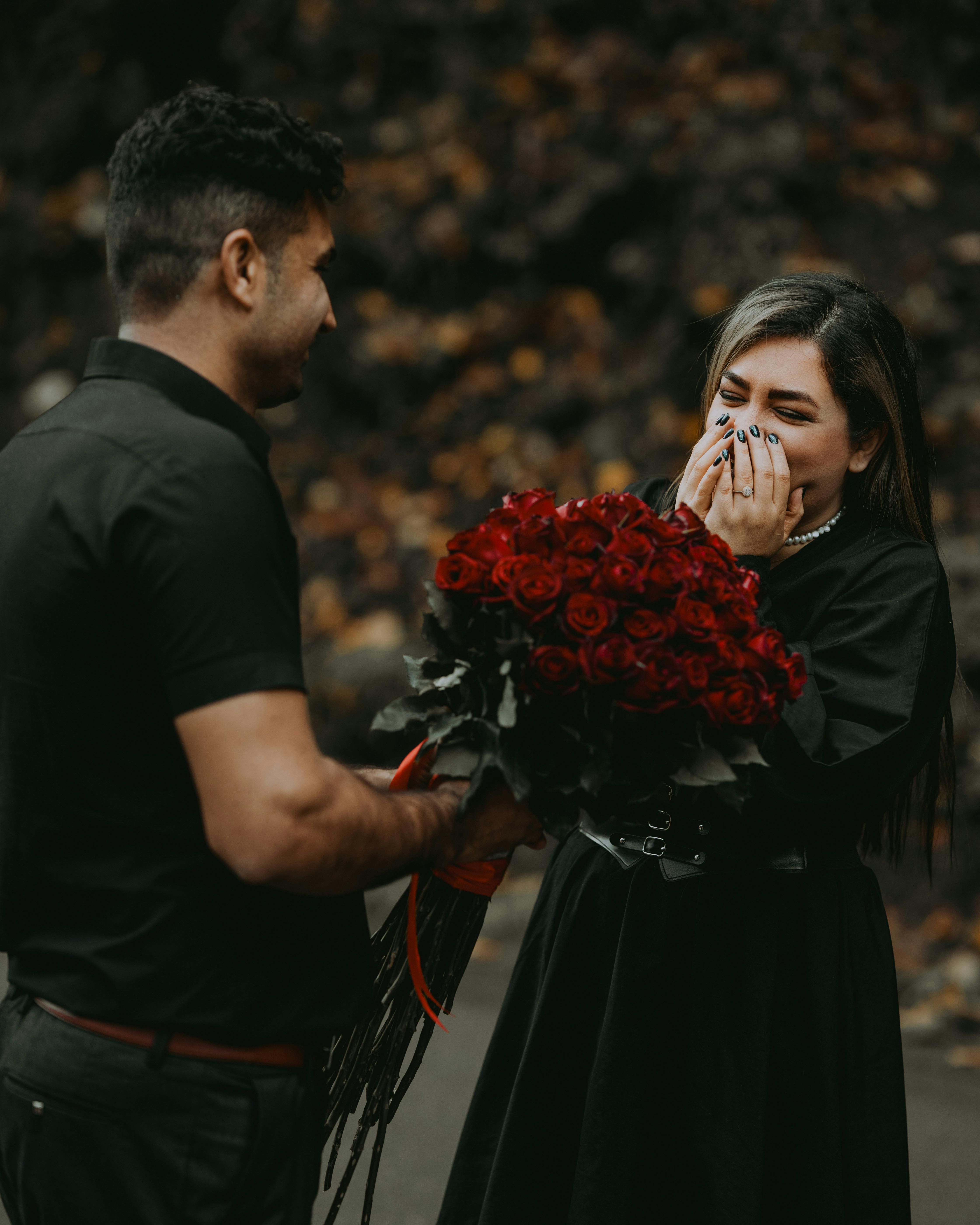 Man Giving Red Roses Bouquet to Happy Woman · Free Stock Photo