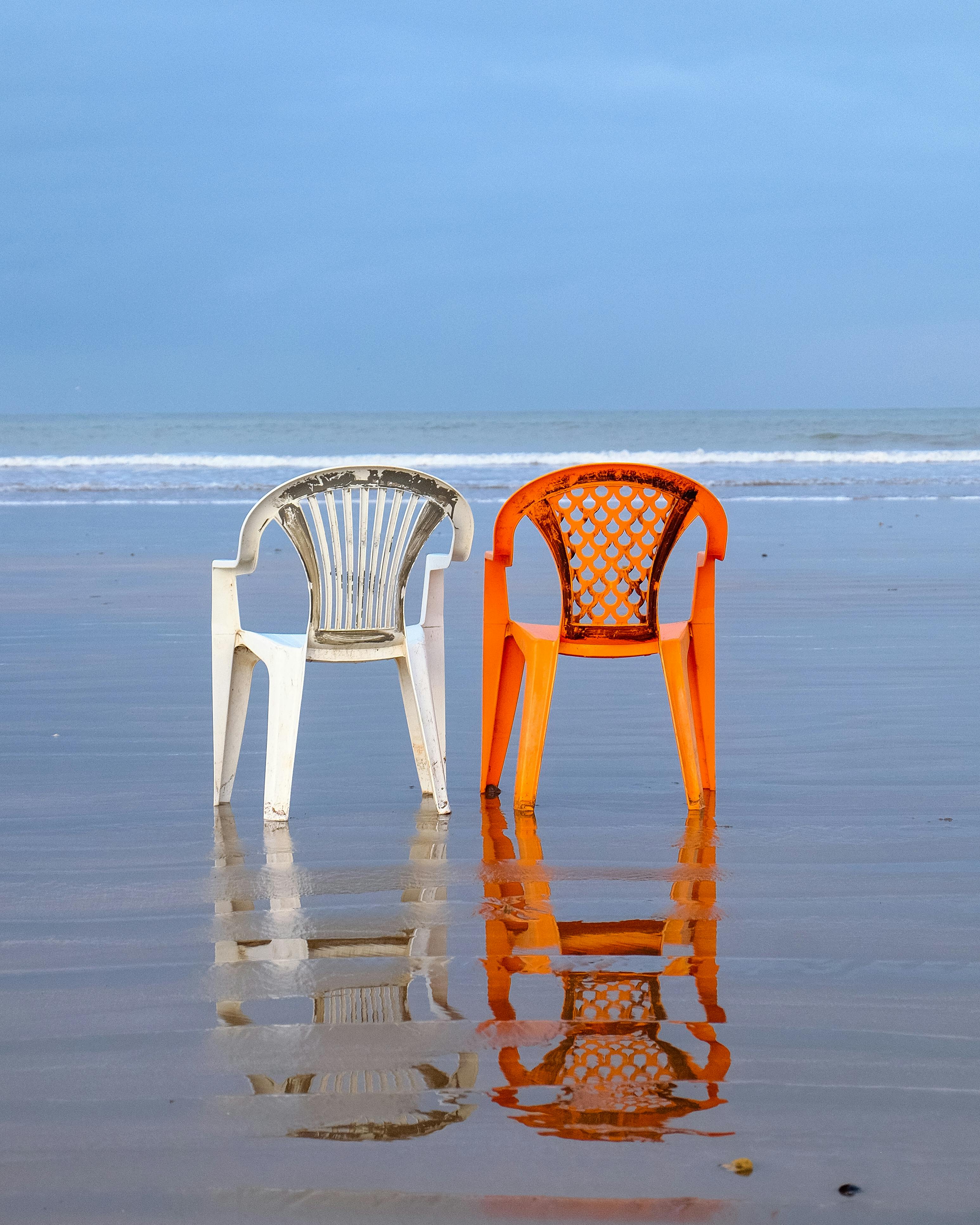 Two Plastic Chairs on the Sea Shore · Free Stock Photo