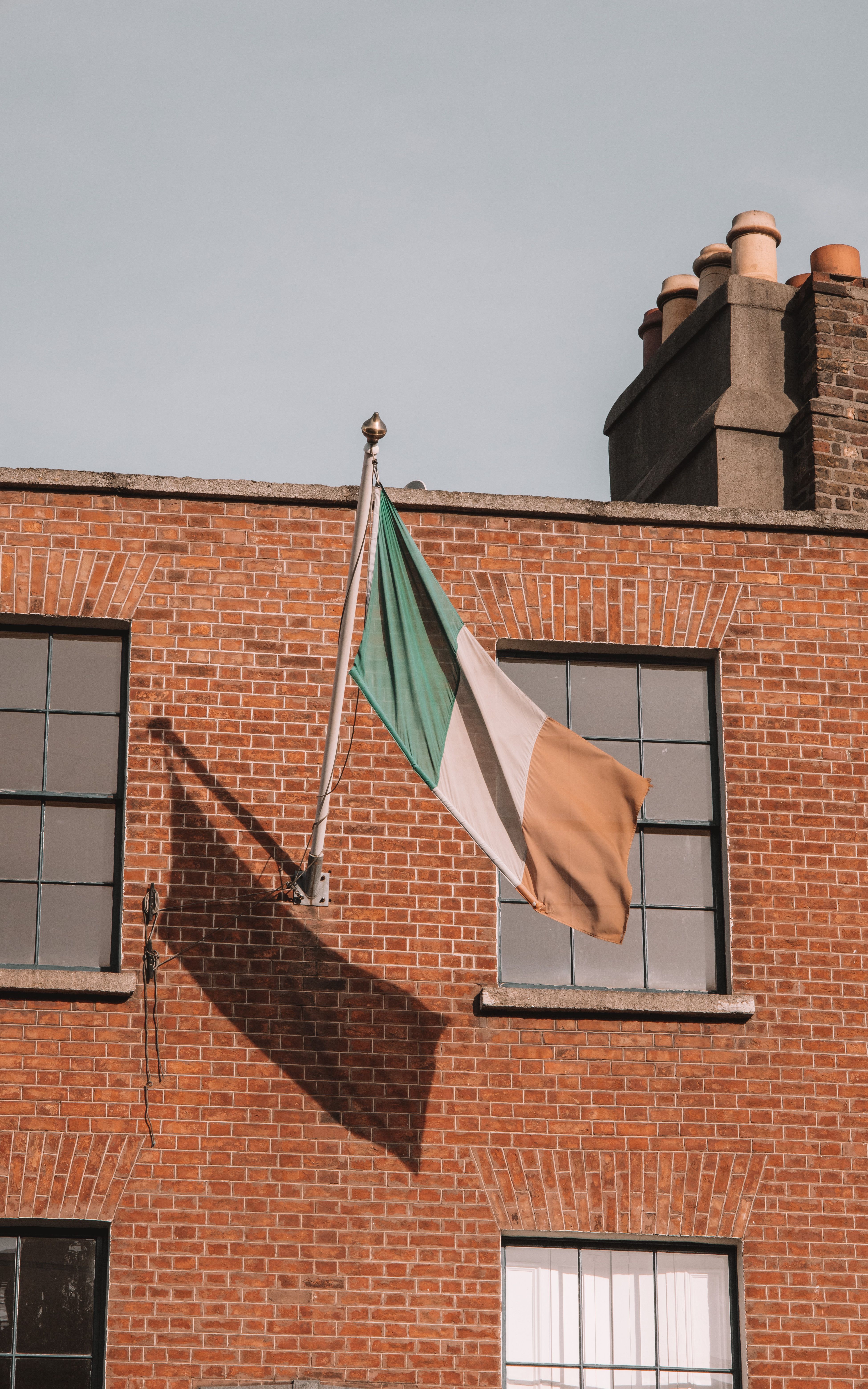 Irish Flag on Wall of Brick Building · Free Stock Photo