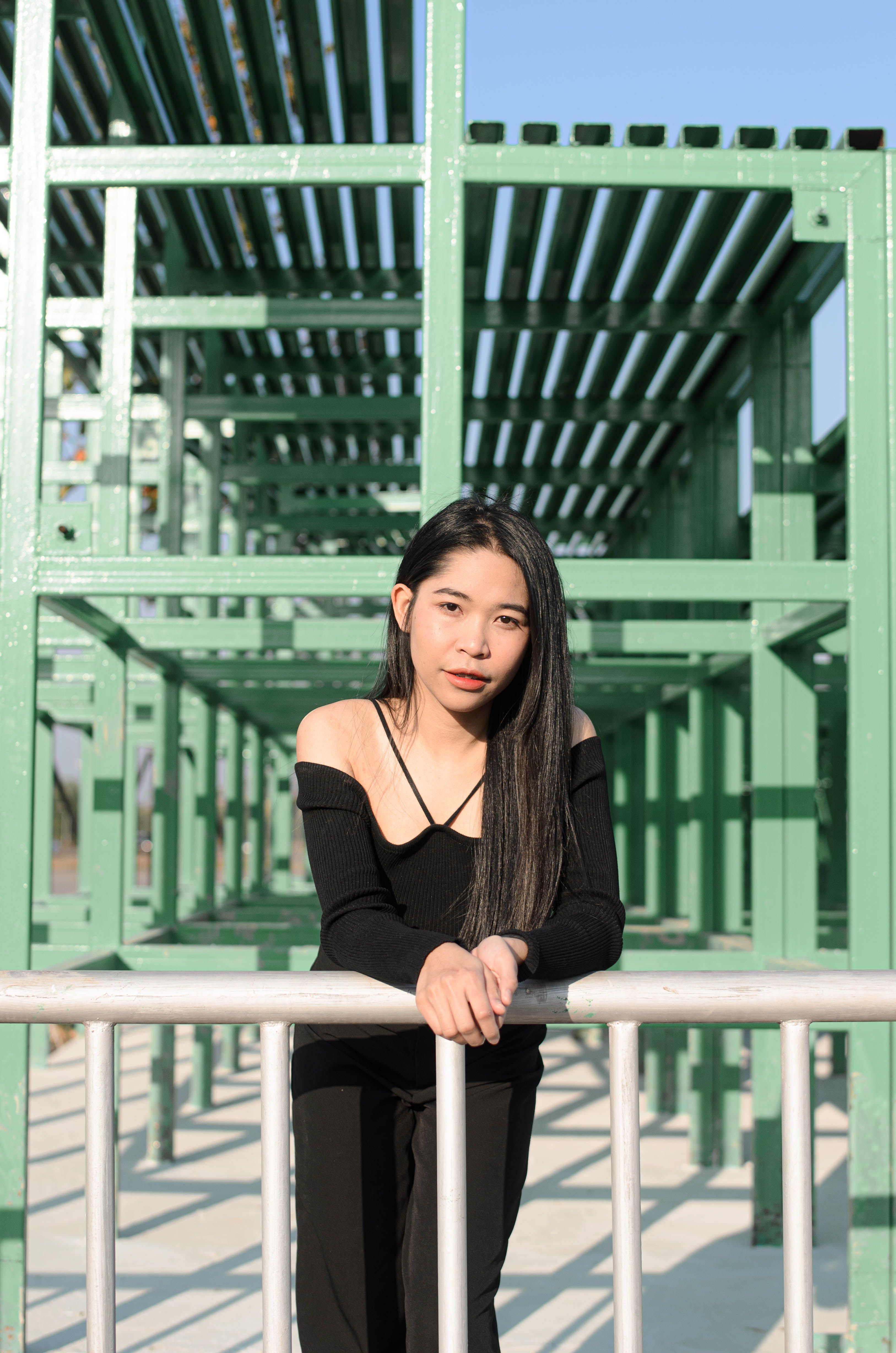 Woman Standing and Leaning on Railing · Free Stock Photo