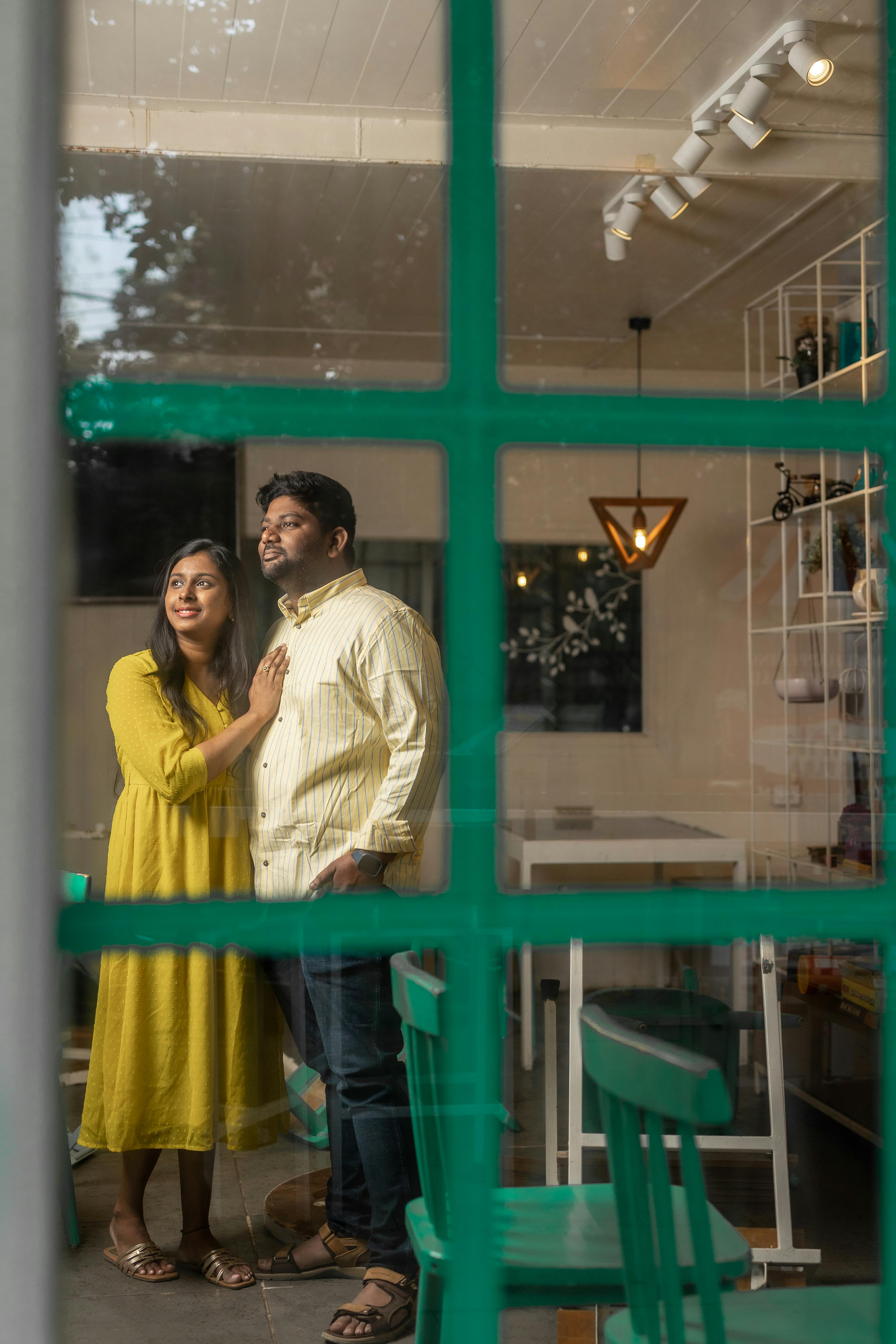 View through Window on Couple Hugging at Home · Free Stock Photo