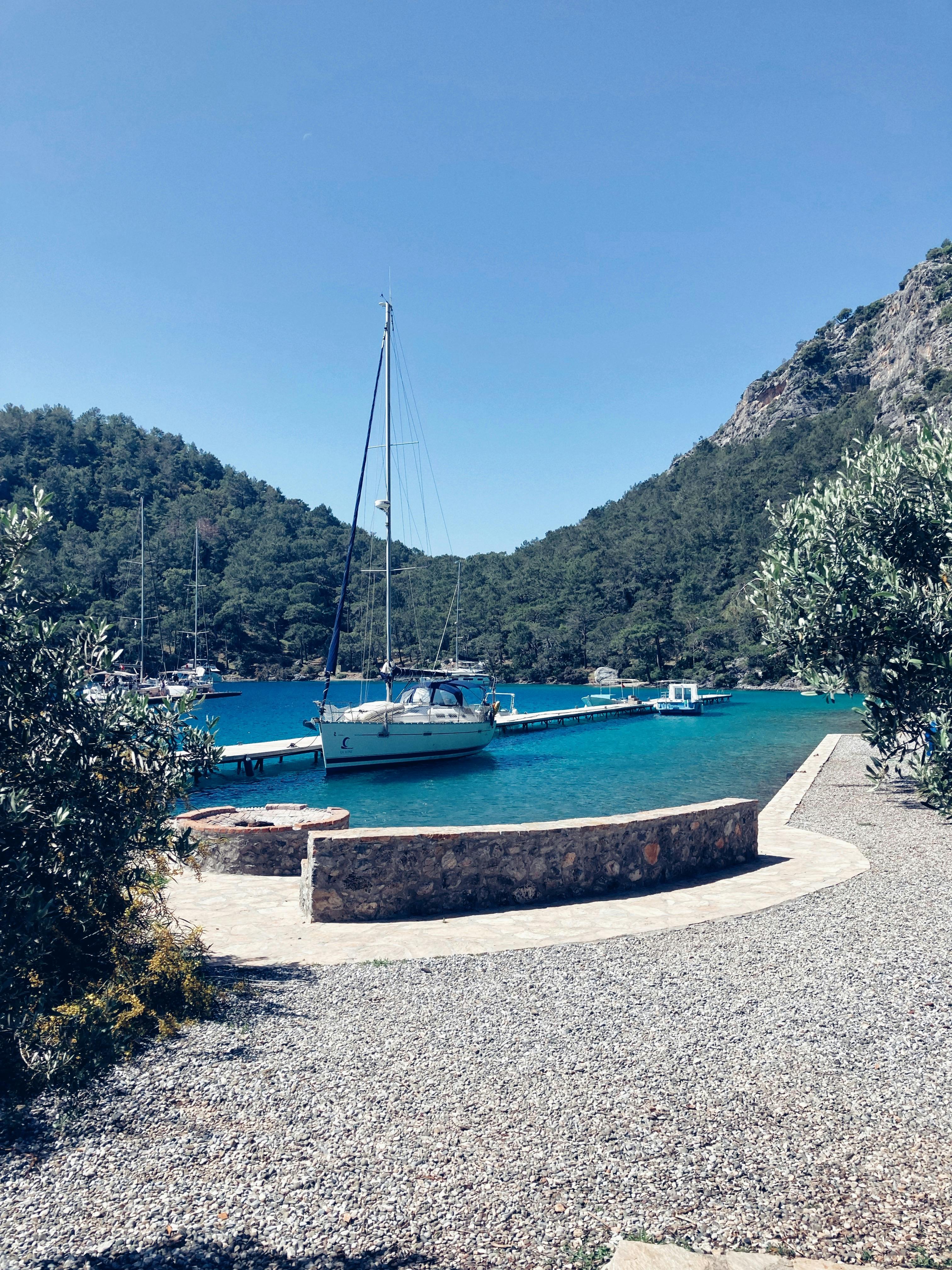 Yacht Moored in Sunlit Bay · Free Stock Photo