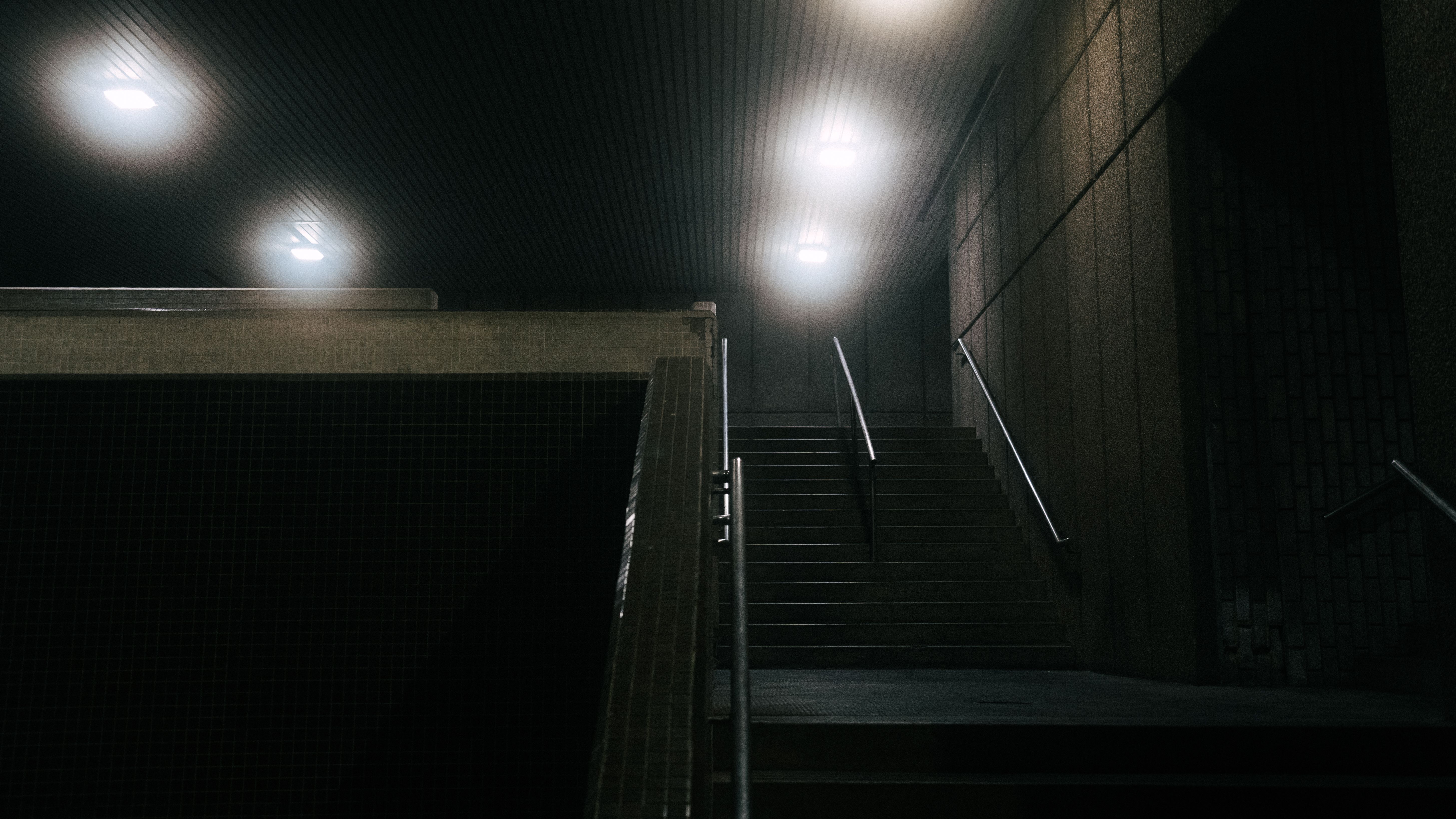 A dark stairway with lights on it · Free Stock Photo