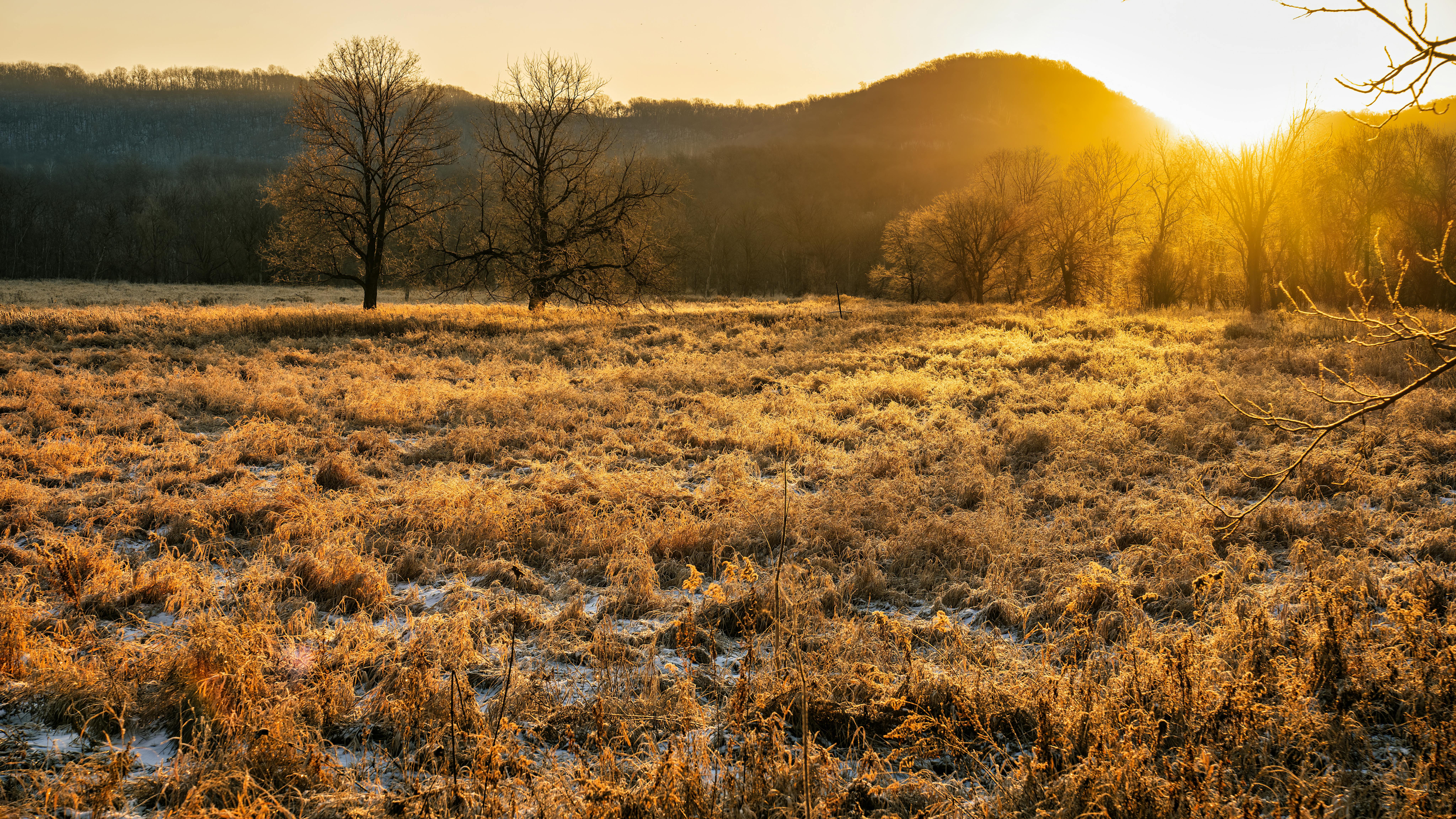 Snow on Grass Field Near a Mountain · Free Stock Photo