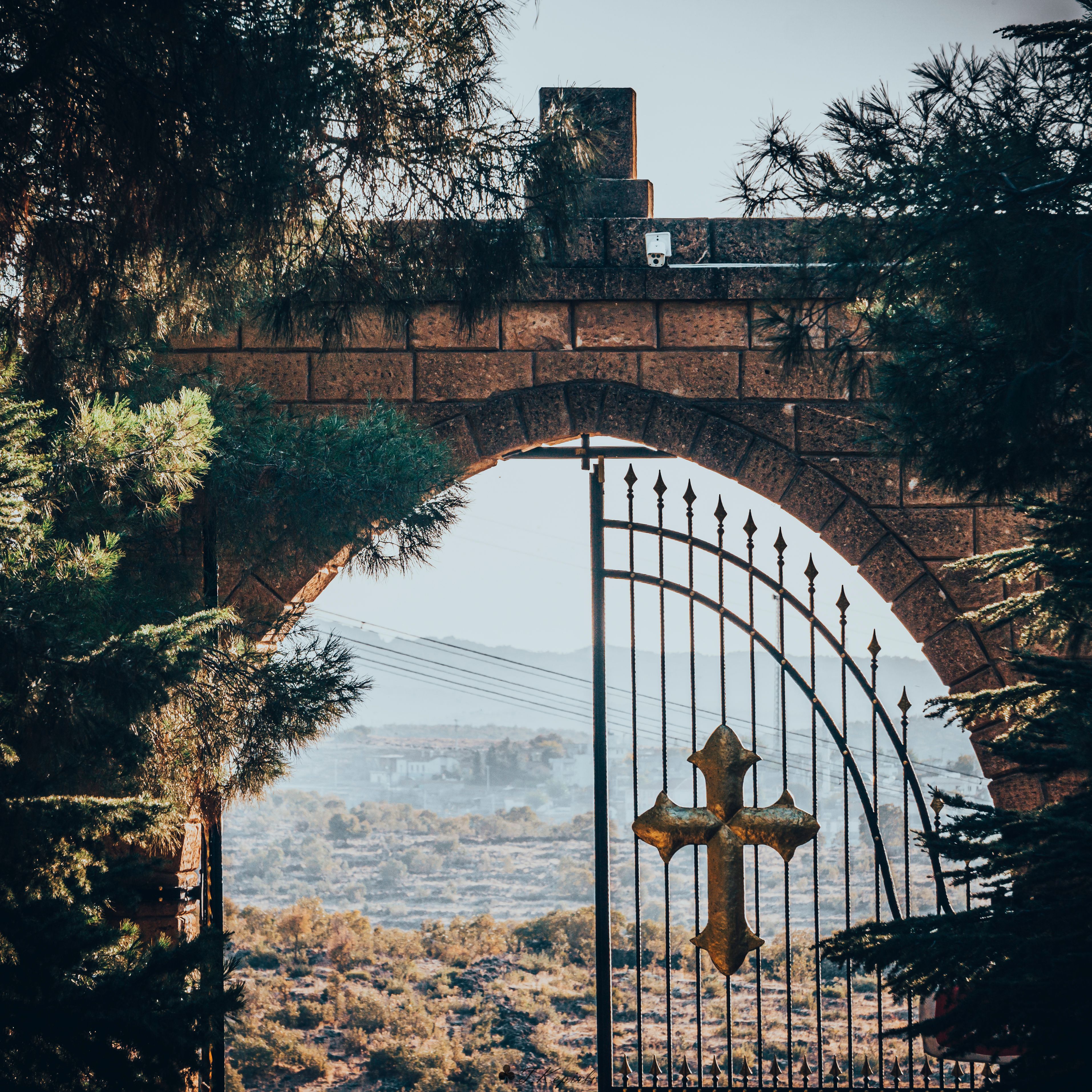 A Gate with a Cross Overlooking the Valley · Free Stock Photo