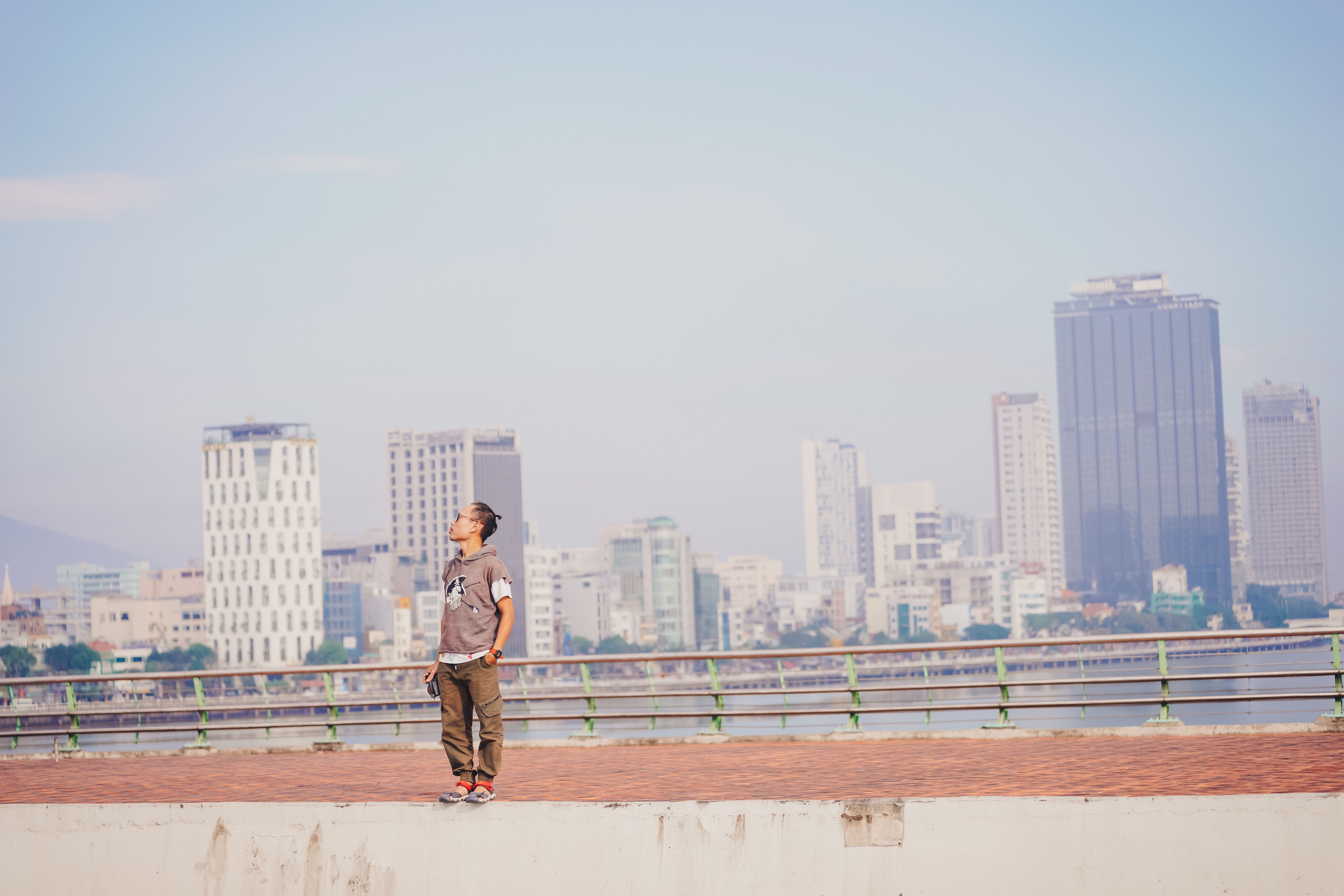 Man Standing near Railing over Water in City · Free Stock Photo