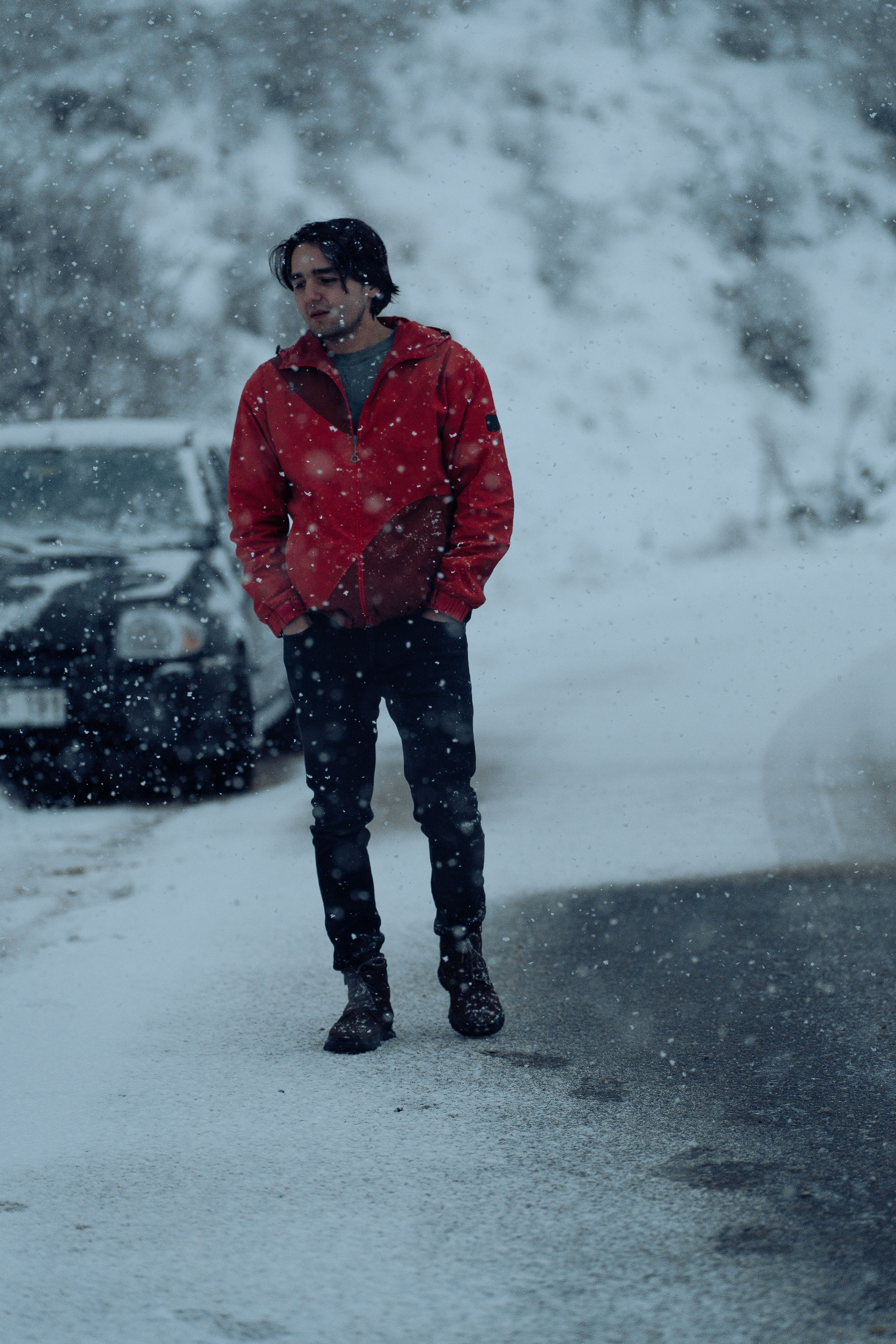 A Man Standing on a Street at Snowfall · Free Stock Photo