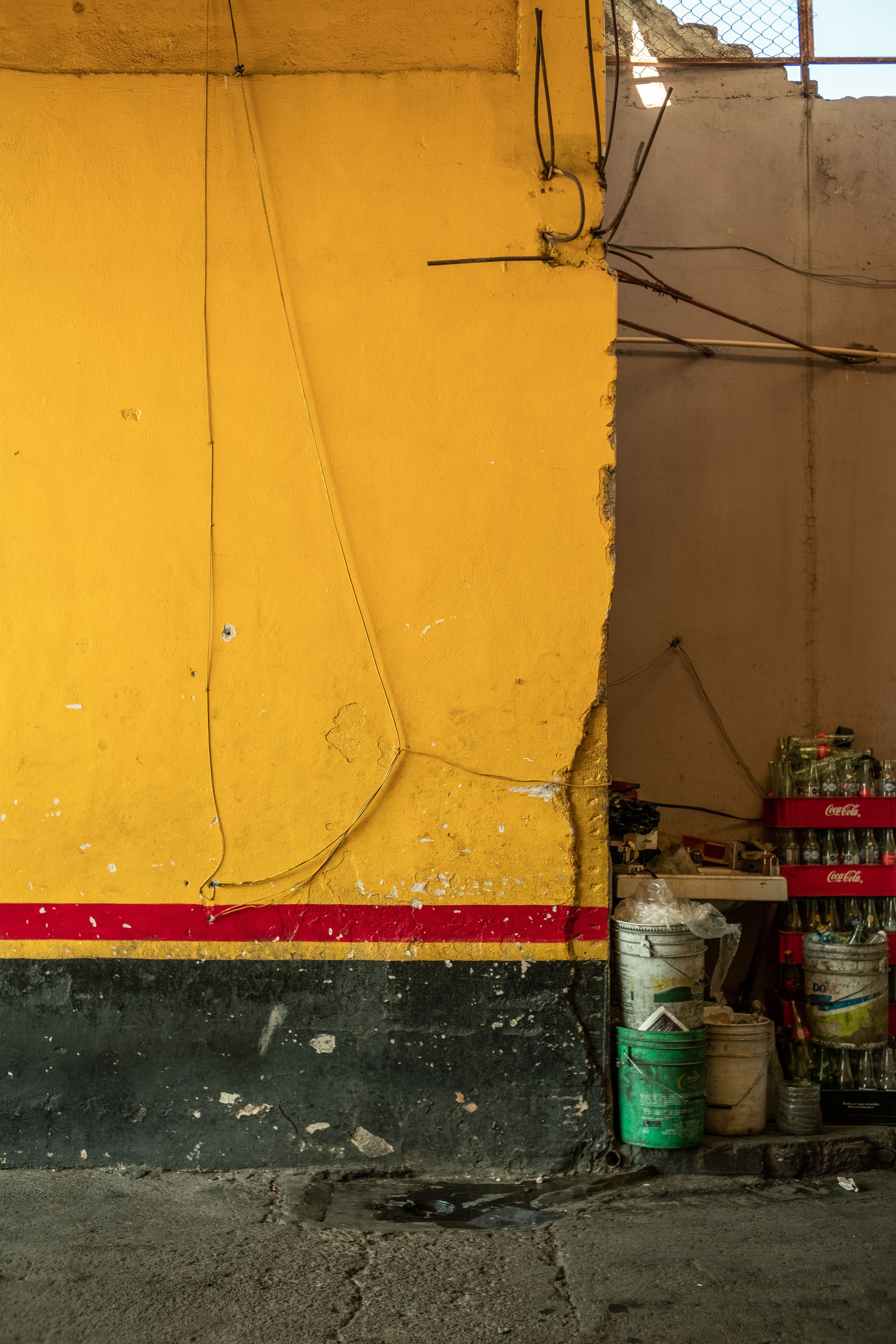 Buckets and Bottles near Warehouse Wall · Free Stock Photo
