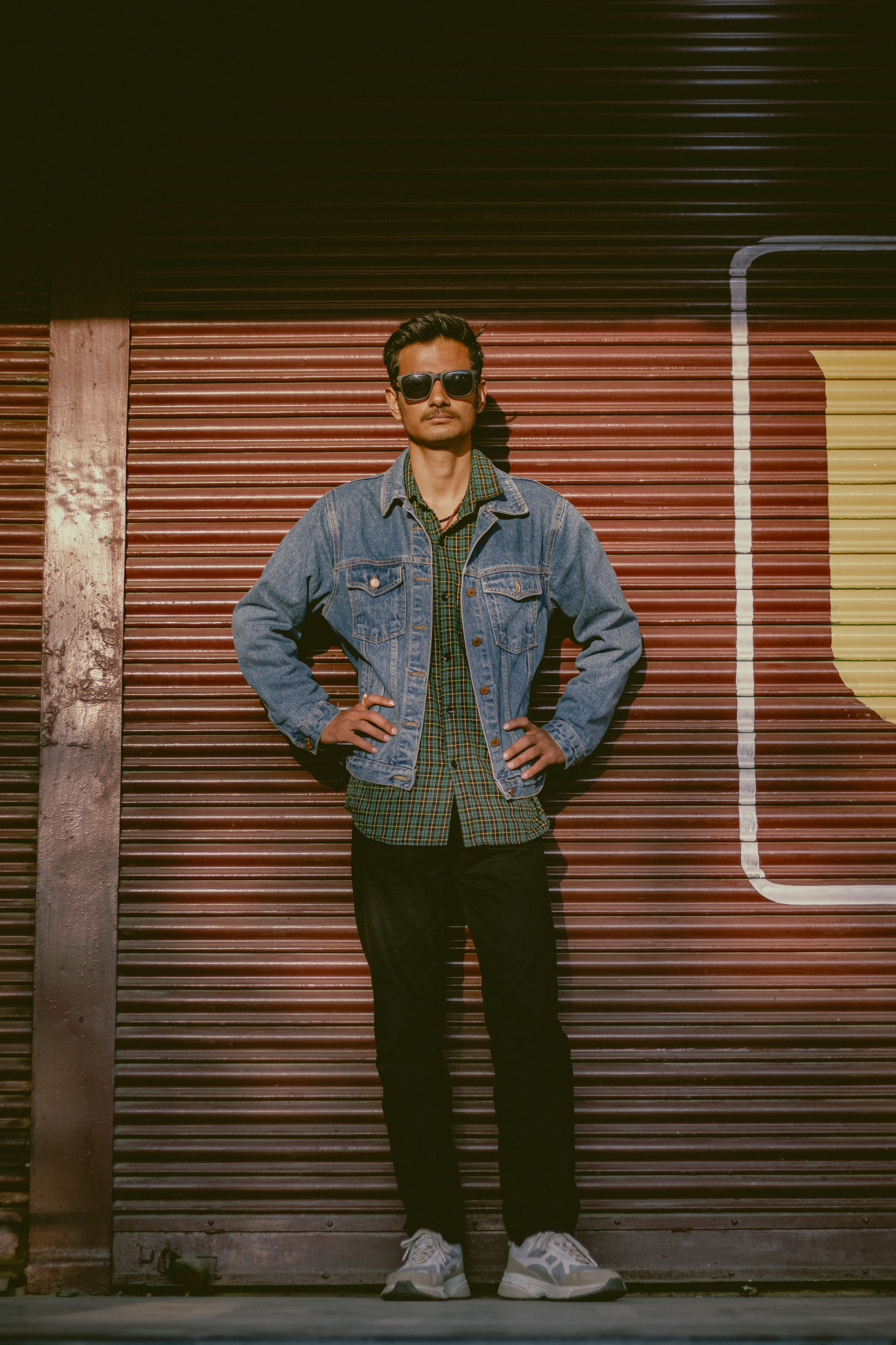 Standing Man in Denim Jacket Holding Hands on Hips · Free Stock Photo