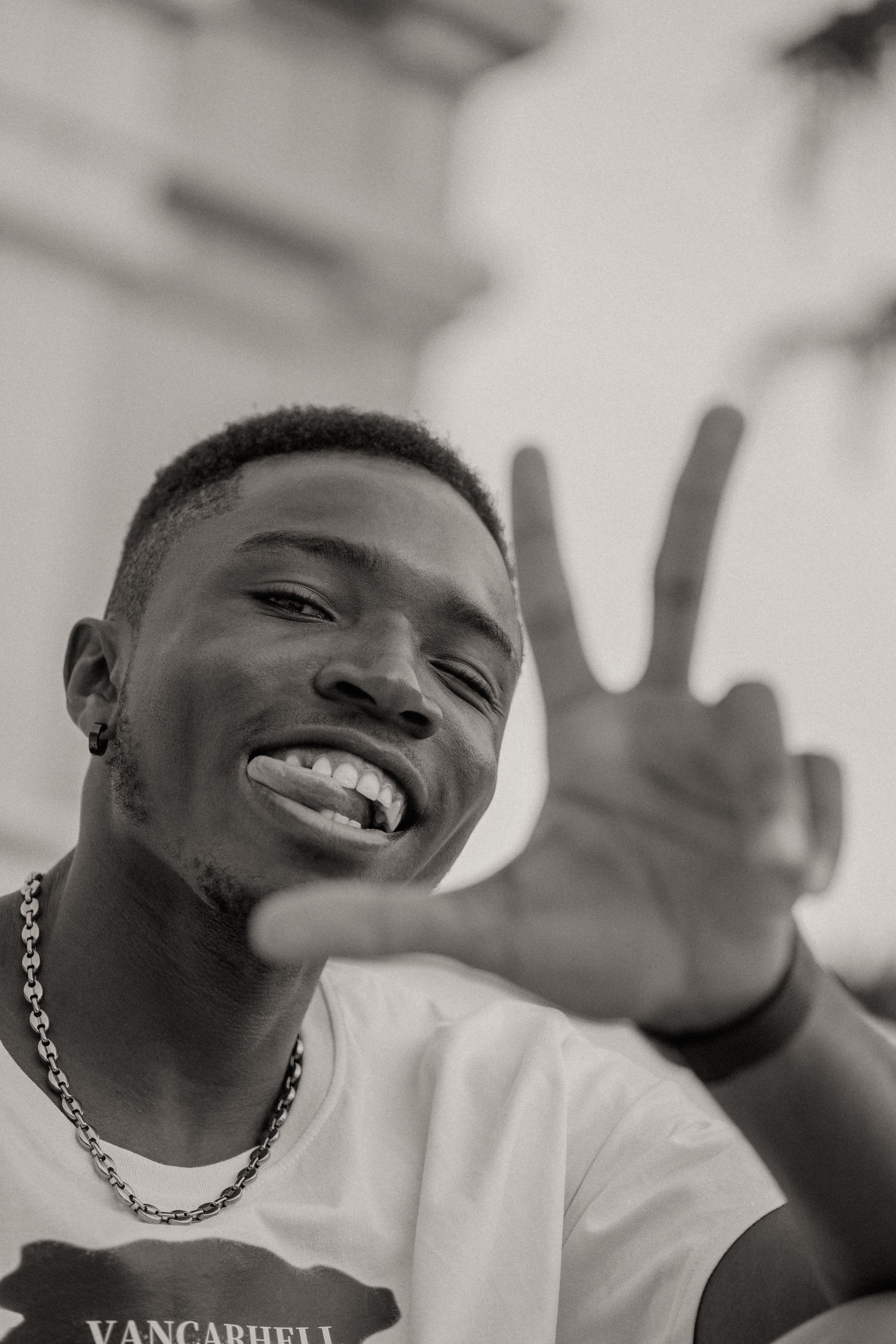 Smiling Man Showing Hand Gesture · Free Stock Photo