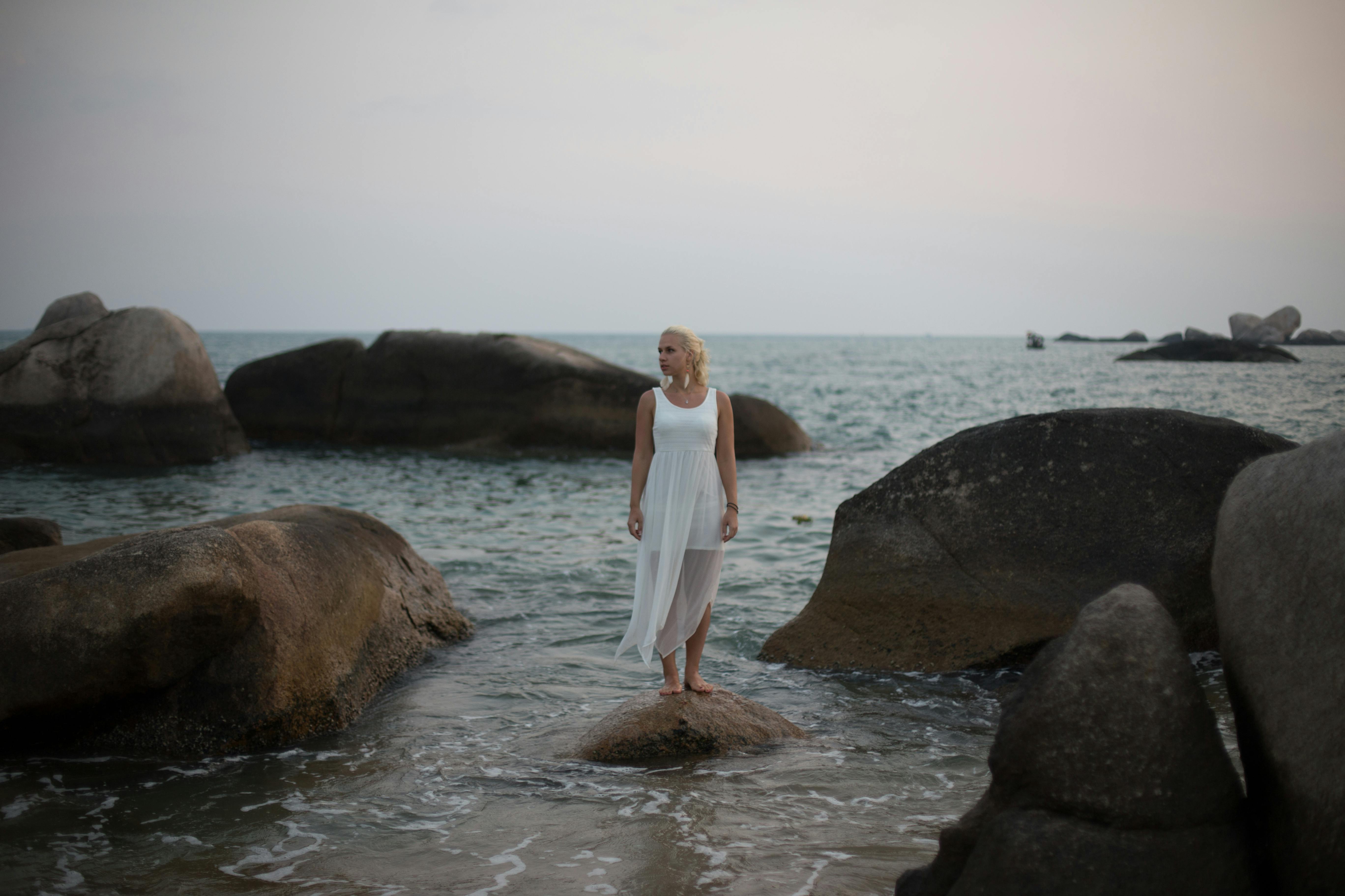 Back View of Woman in Black Dress on Sea Shore · Free Stock Photo
