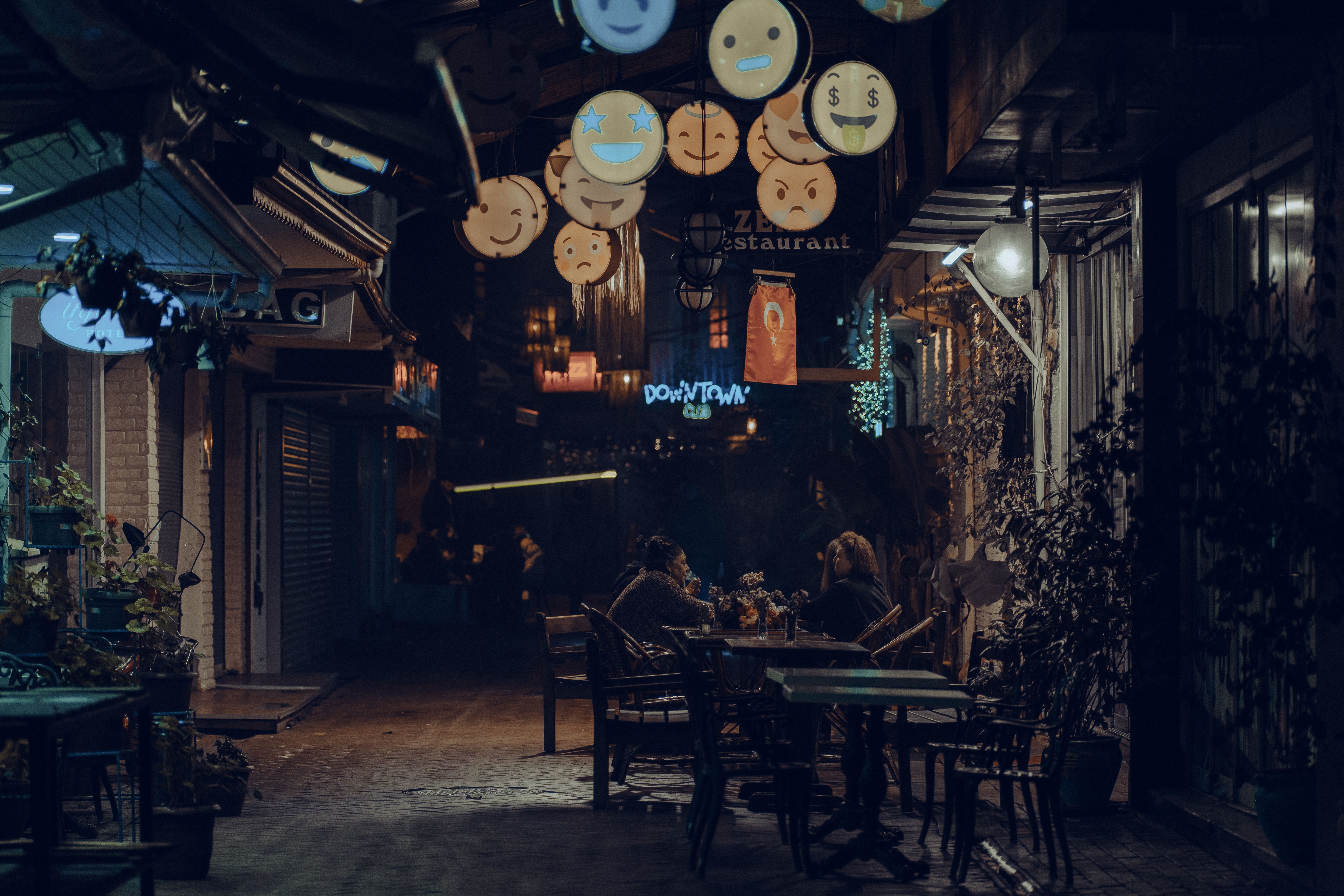 Emojis Decorations over People in Restaurant in Alley at Night · Free ...