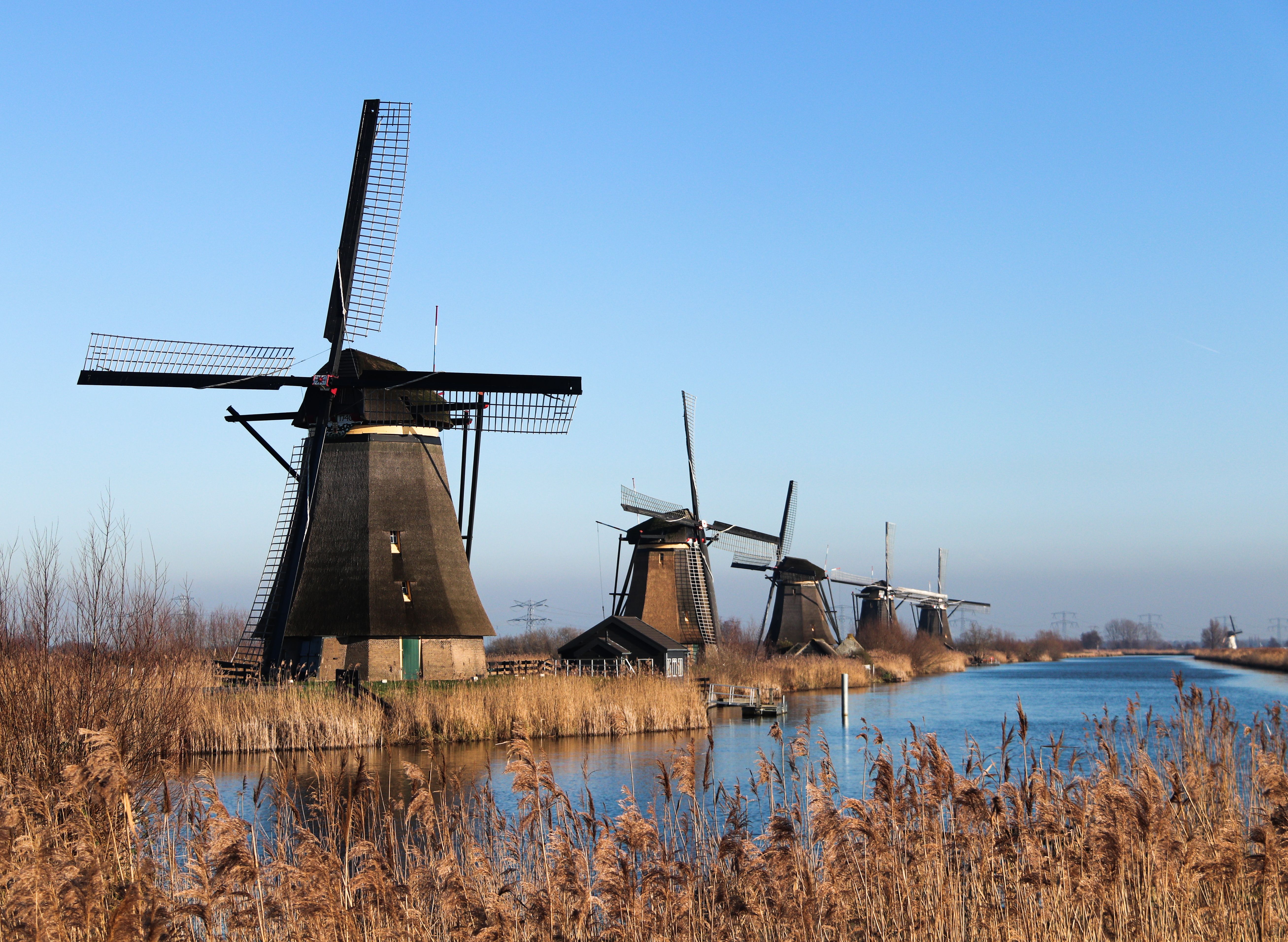 Row of Old Windmills along Canal · Free Stock Photo