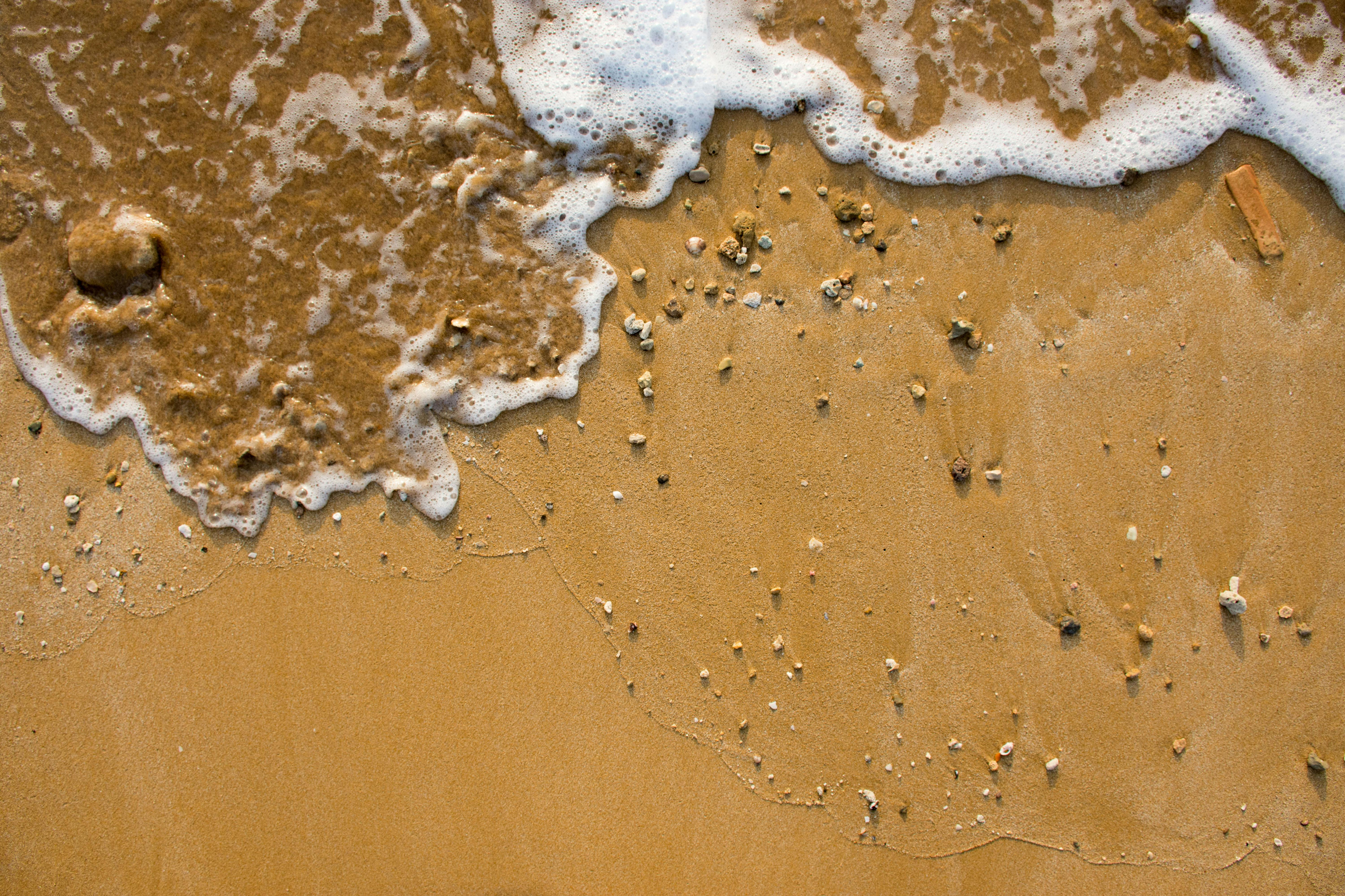 Close-up, Top View of a Wave Washing Up the Beach · Free Stock Photo