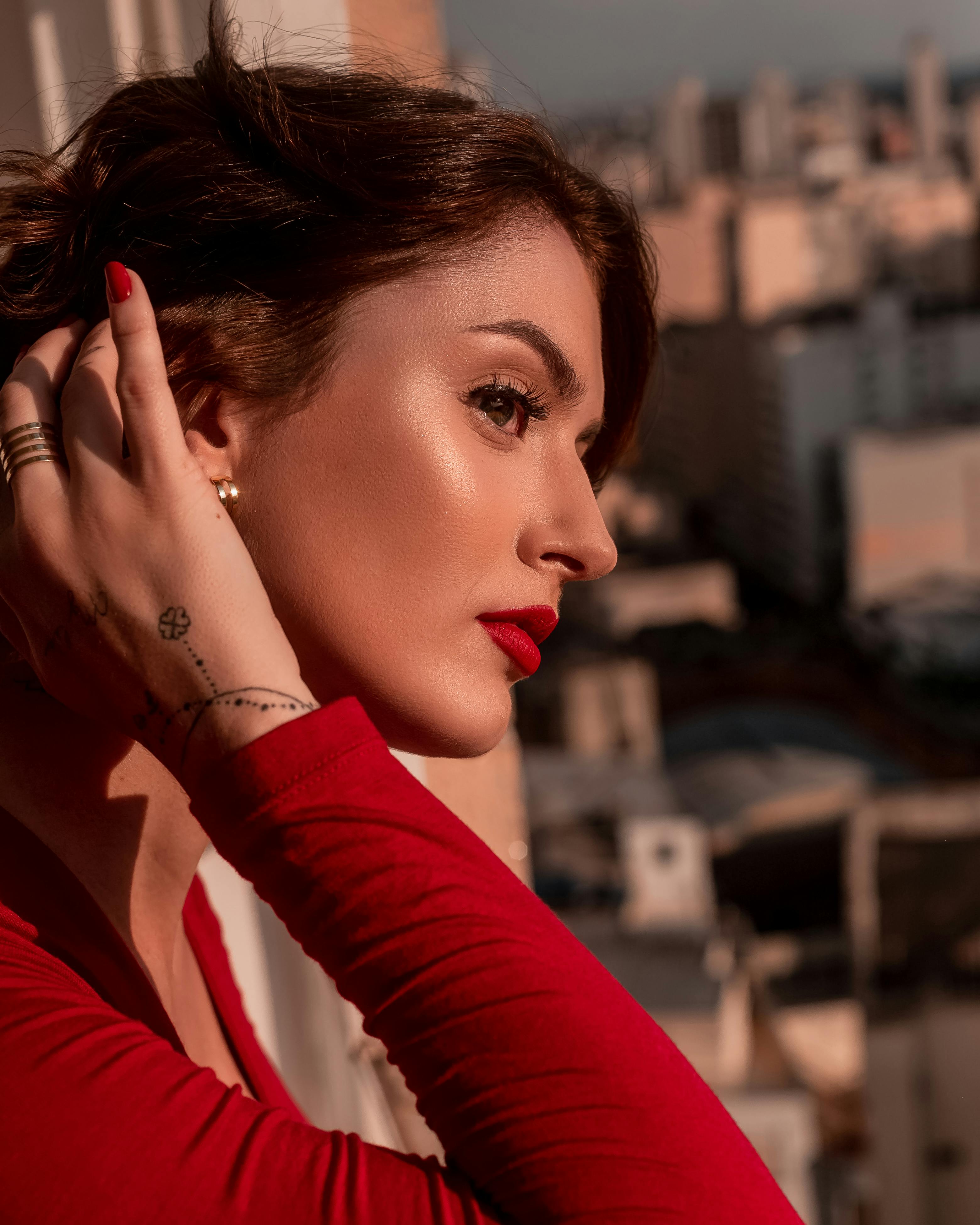 Side View of a Young Woman Wearing a Red Blouse and Red Lipstick ...