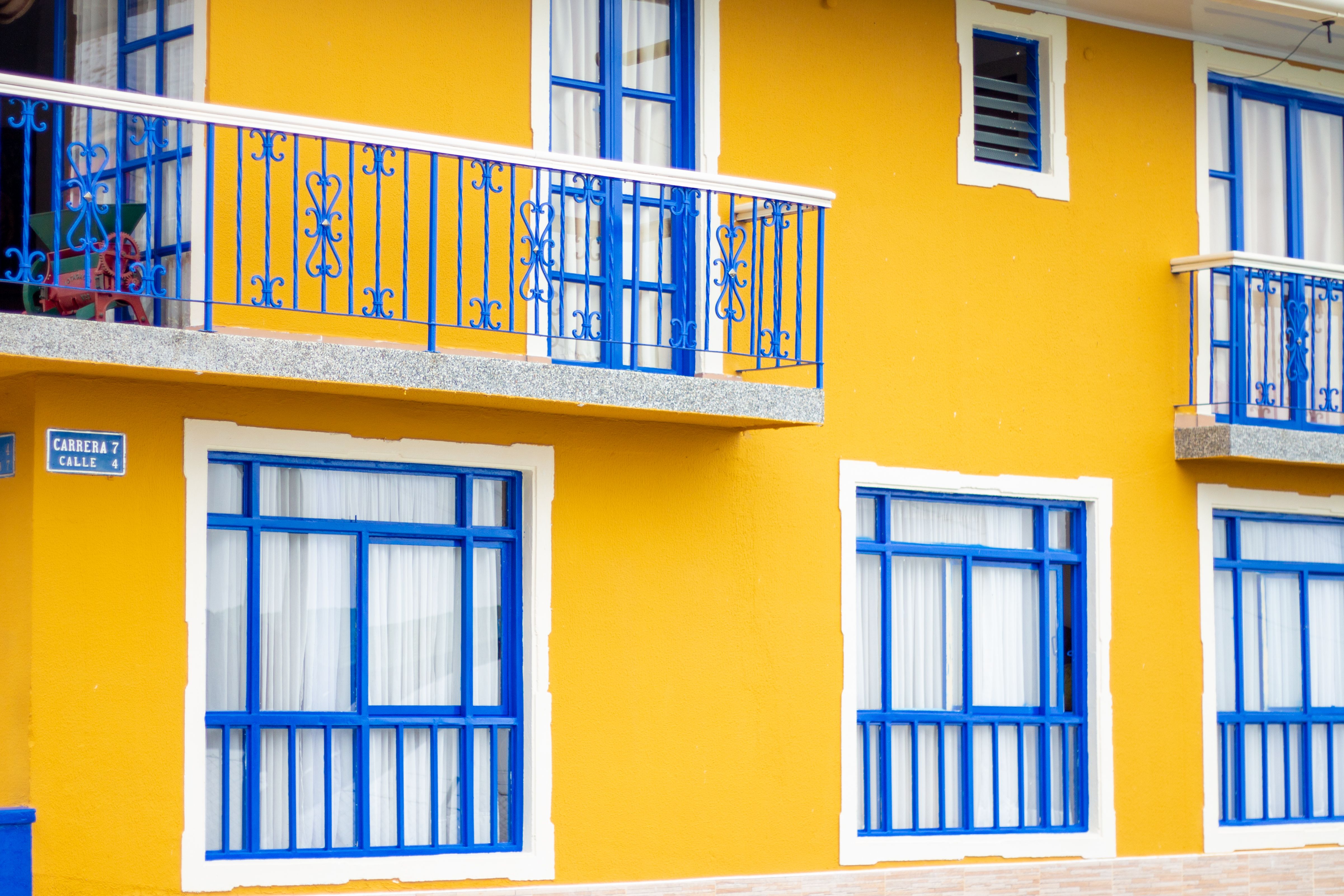 Yellow Building Facade and Blue Windows · Free Stock Photo