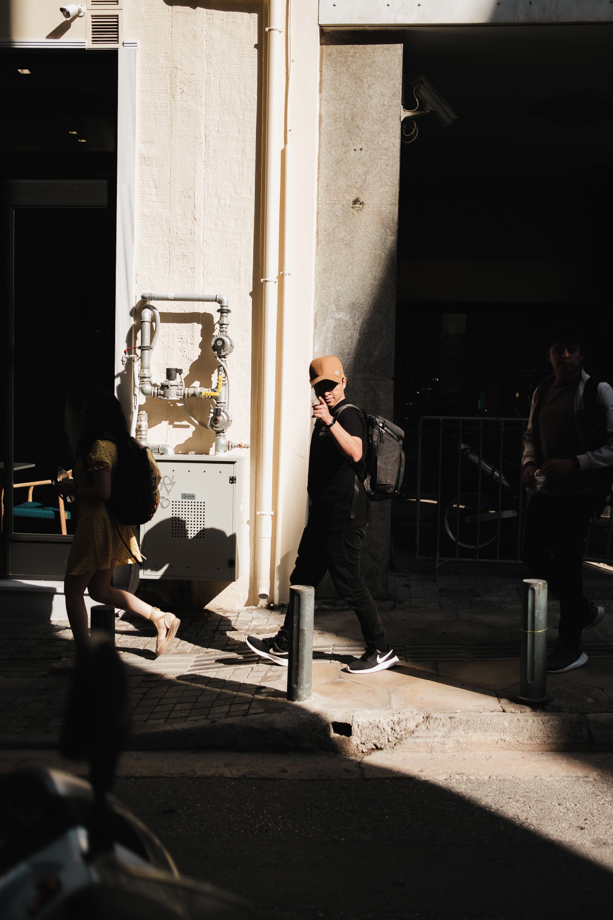 Backpacker Walking Past a Building · Free Stock Photo