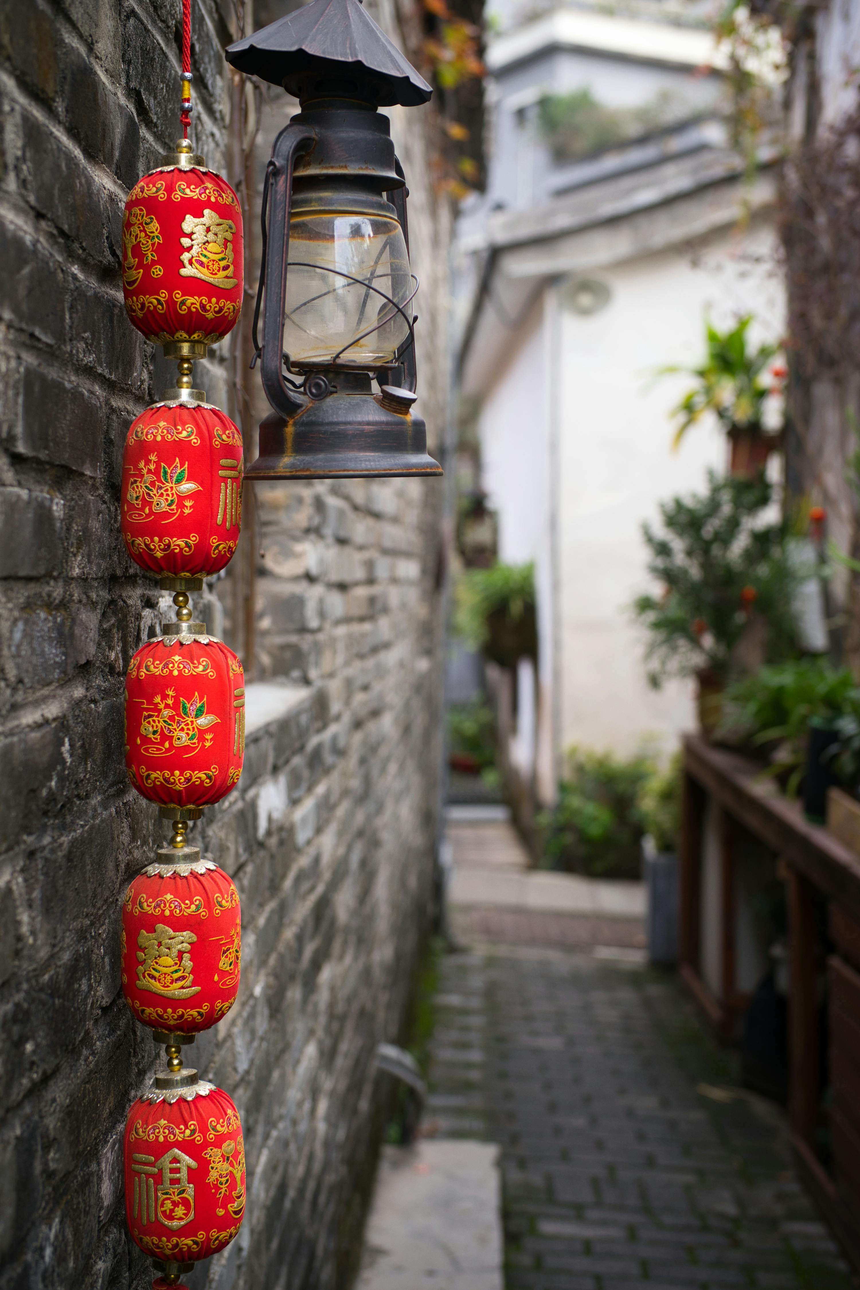 Traditional Decorations near Lamp on Wall · Free Stock Photo