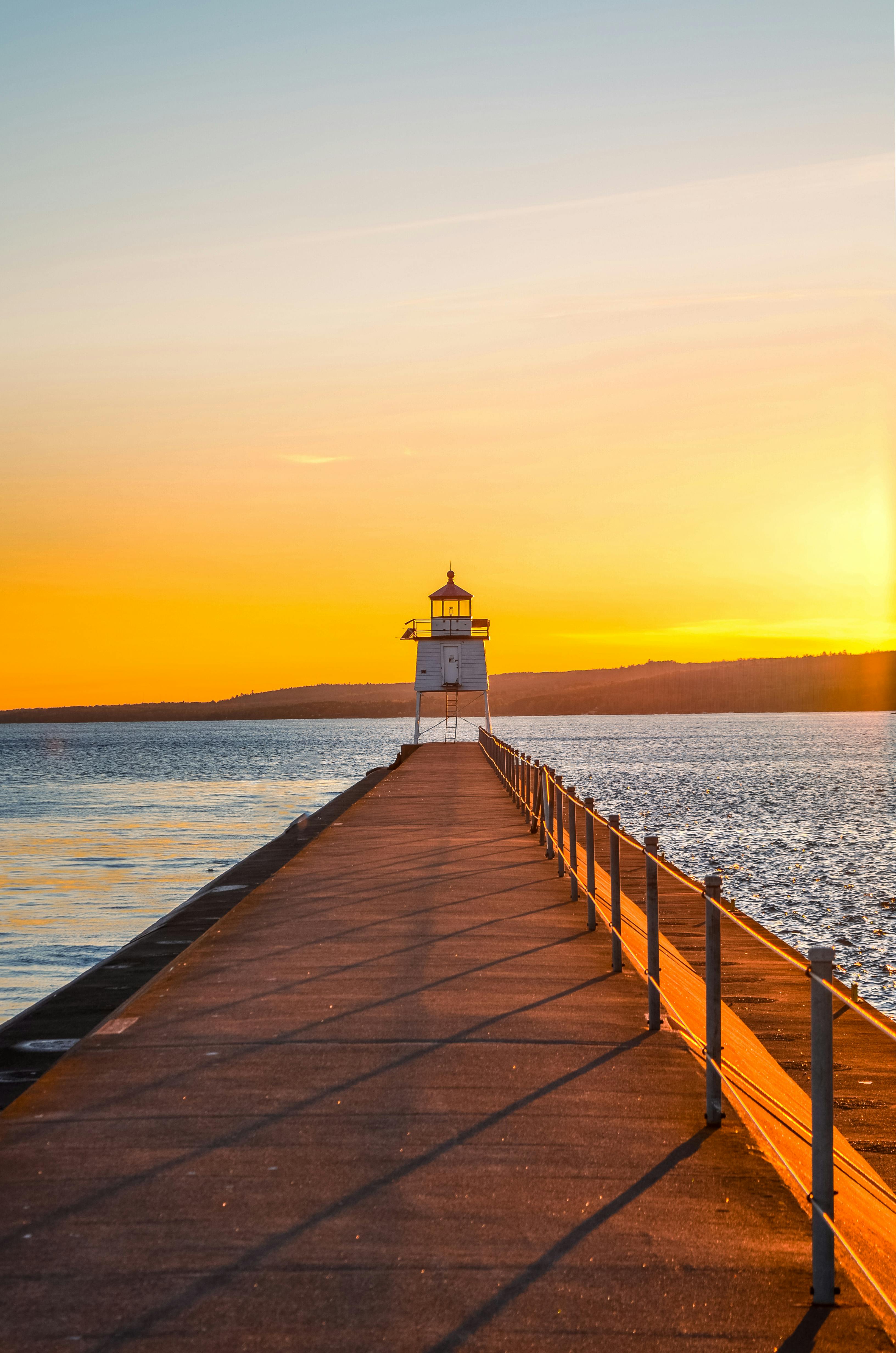 Lighthouse on Pier at Sunset · Free Stock Photo