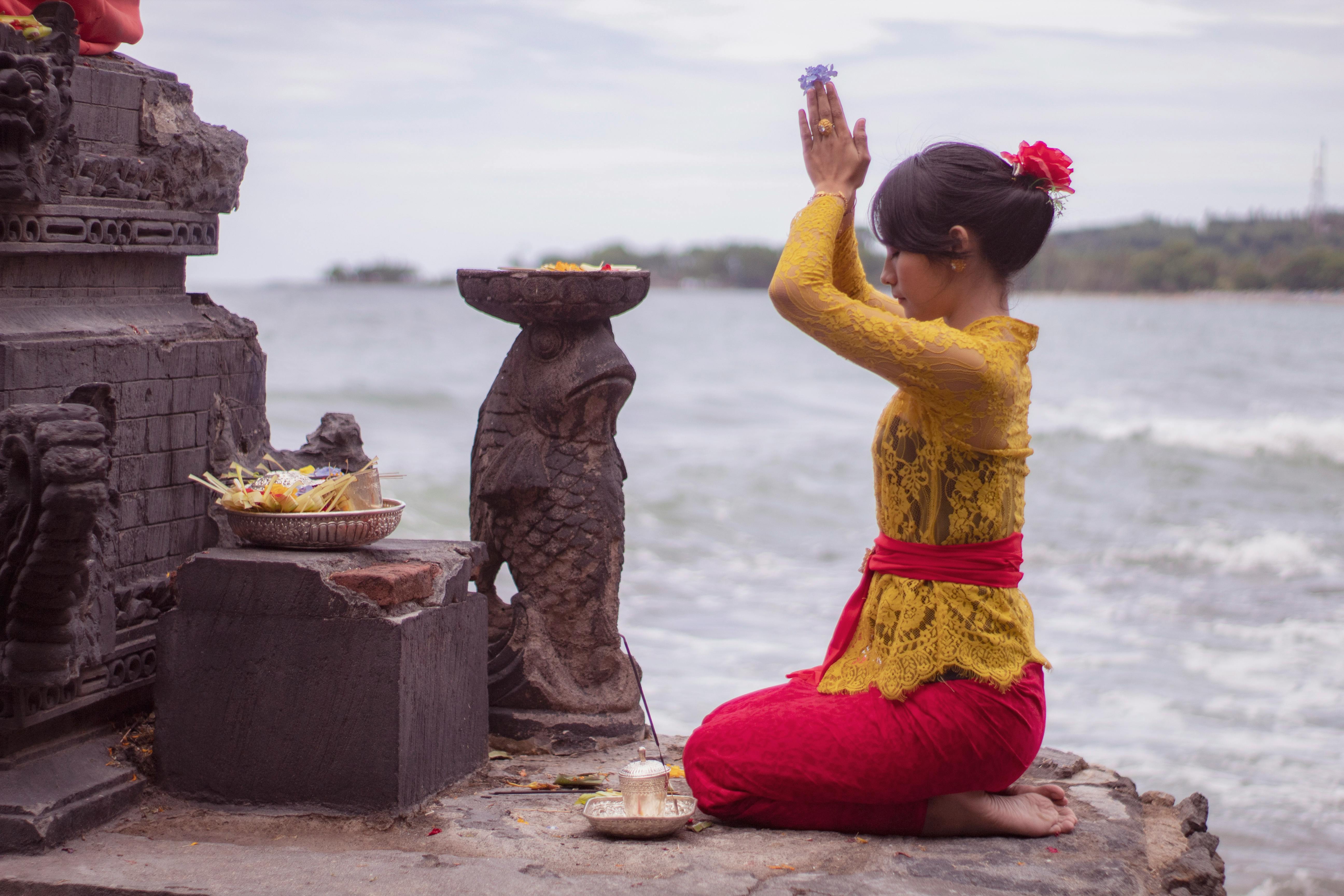 A Woman Kneeling at a Shrine · Free Stock Photo