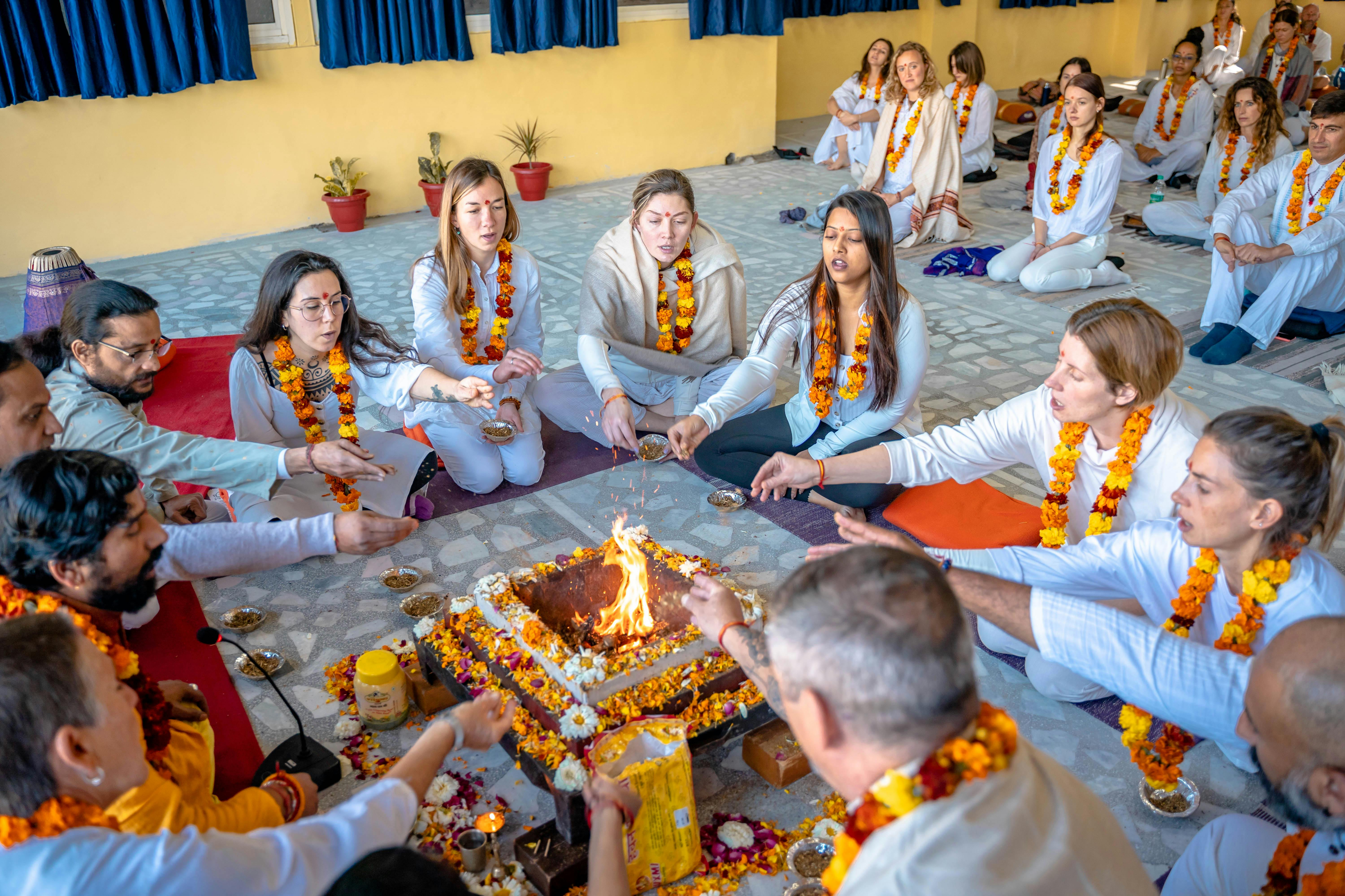 People Sitting around Burning Altar with Flowers · Free Stock Photo