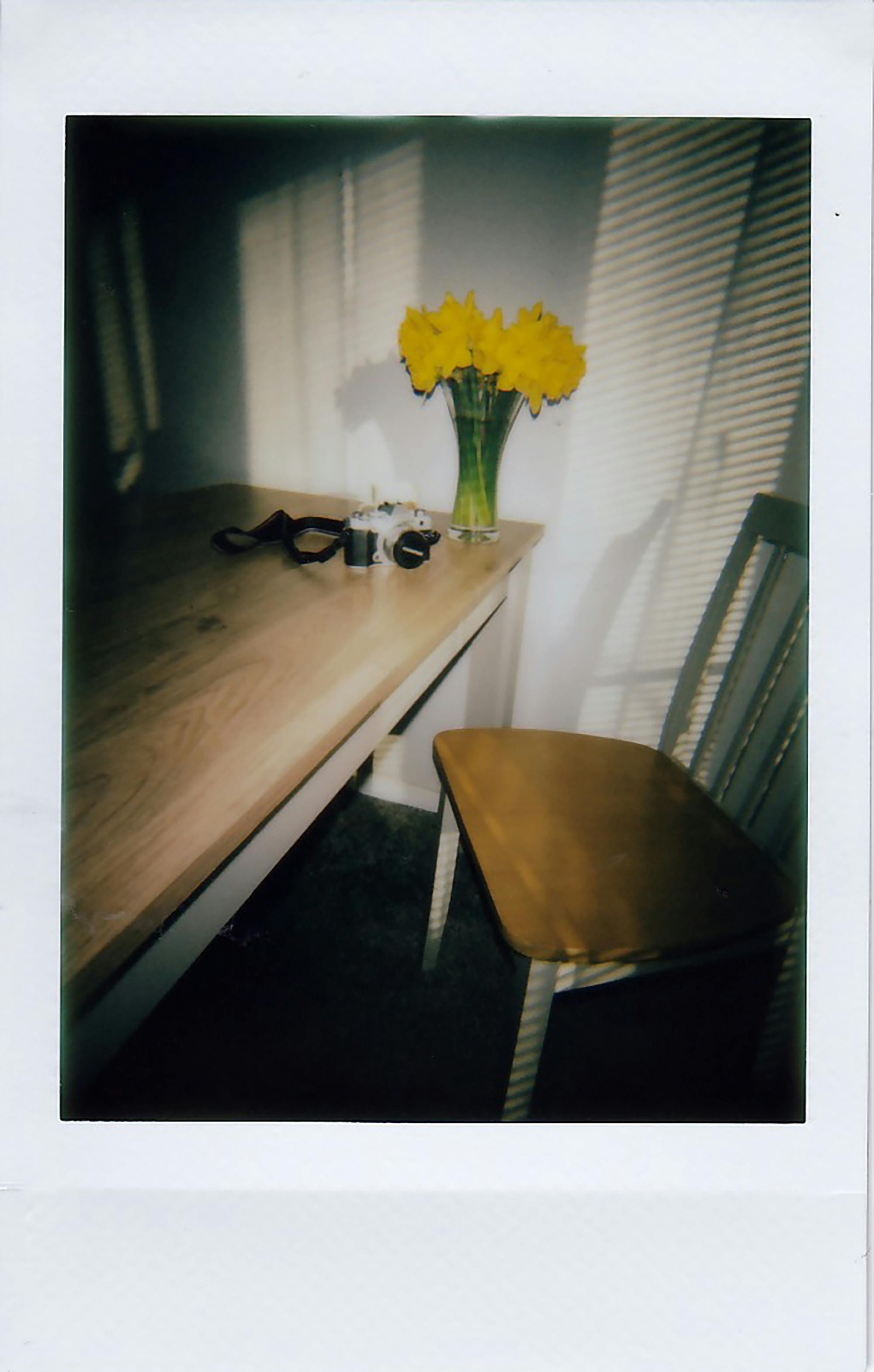 Camera an dVase with Daffodils on Table · Free Stock Photo