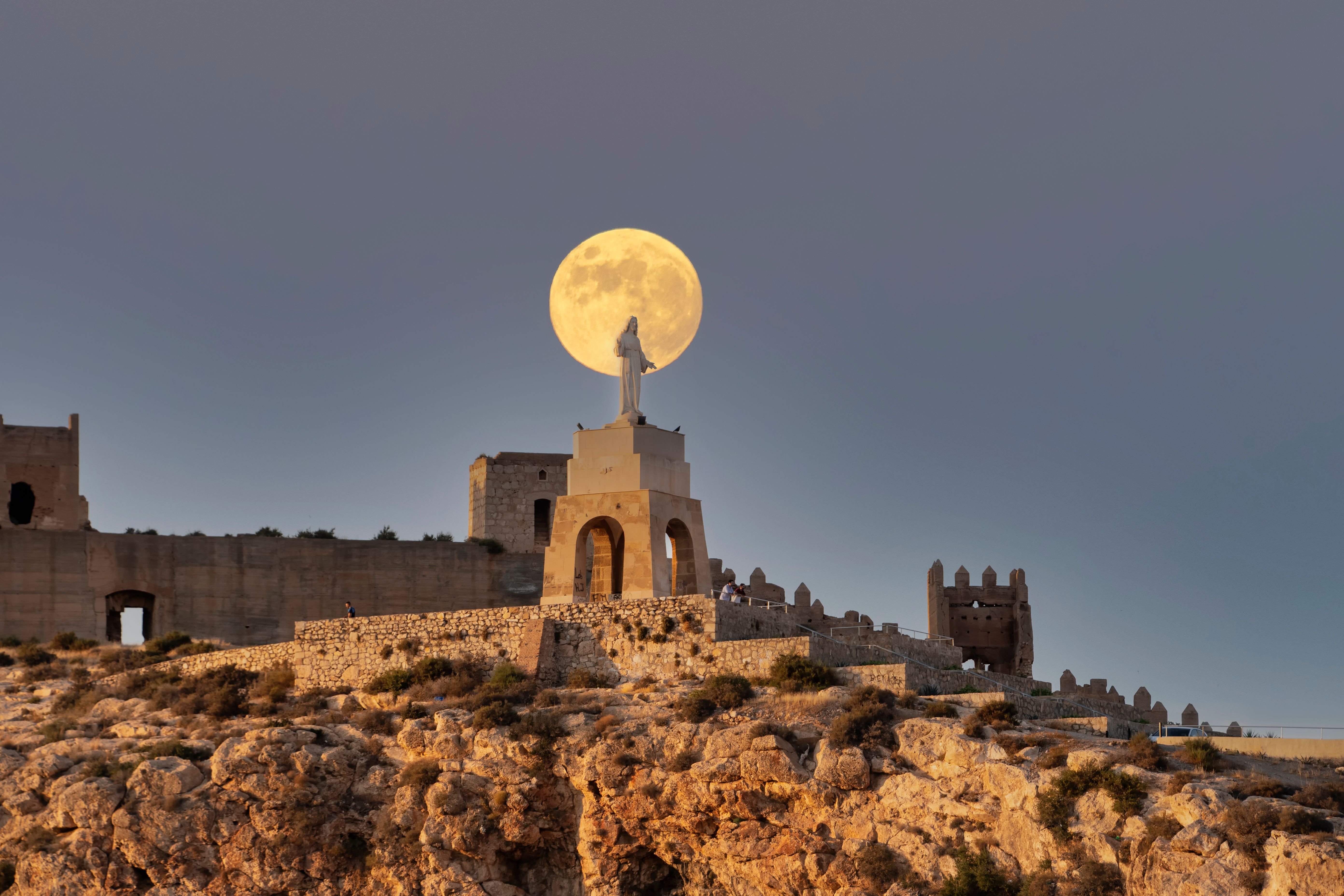 Full Moon over Statue over Walls on Rocks · Free Stock Photo