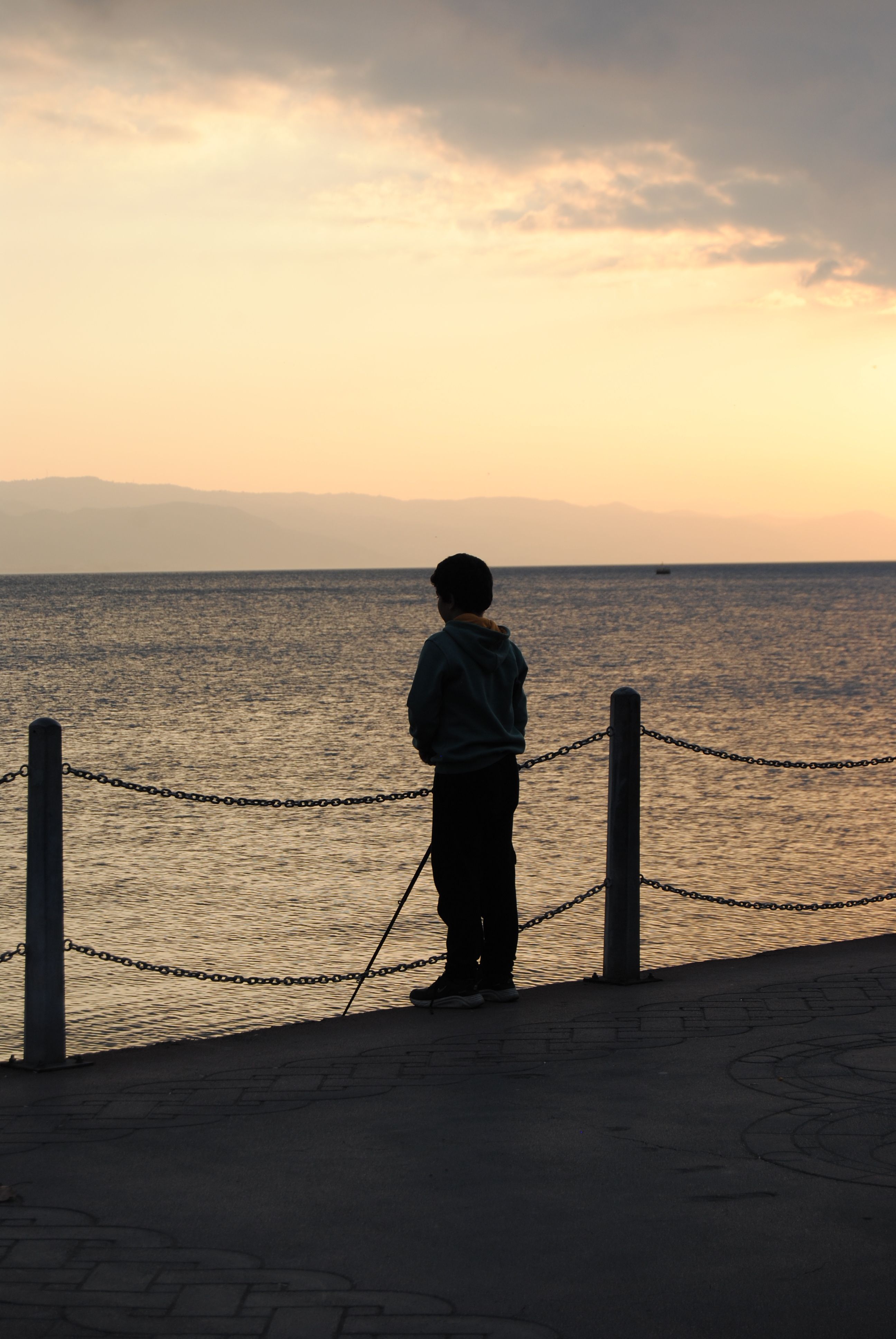 Boy Fishing on Shore at Sunset · Free Stock Photo