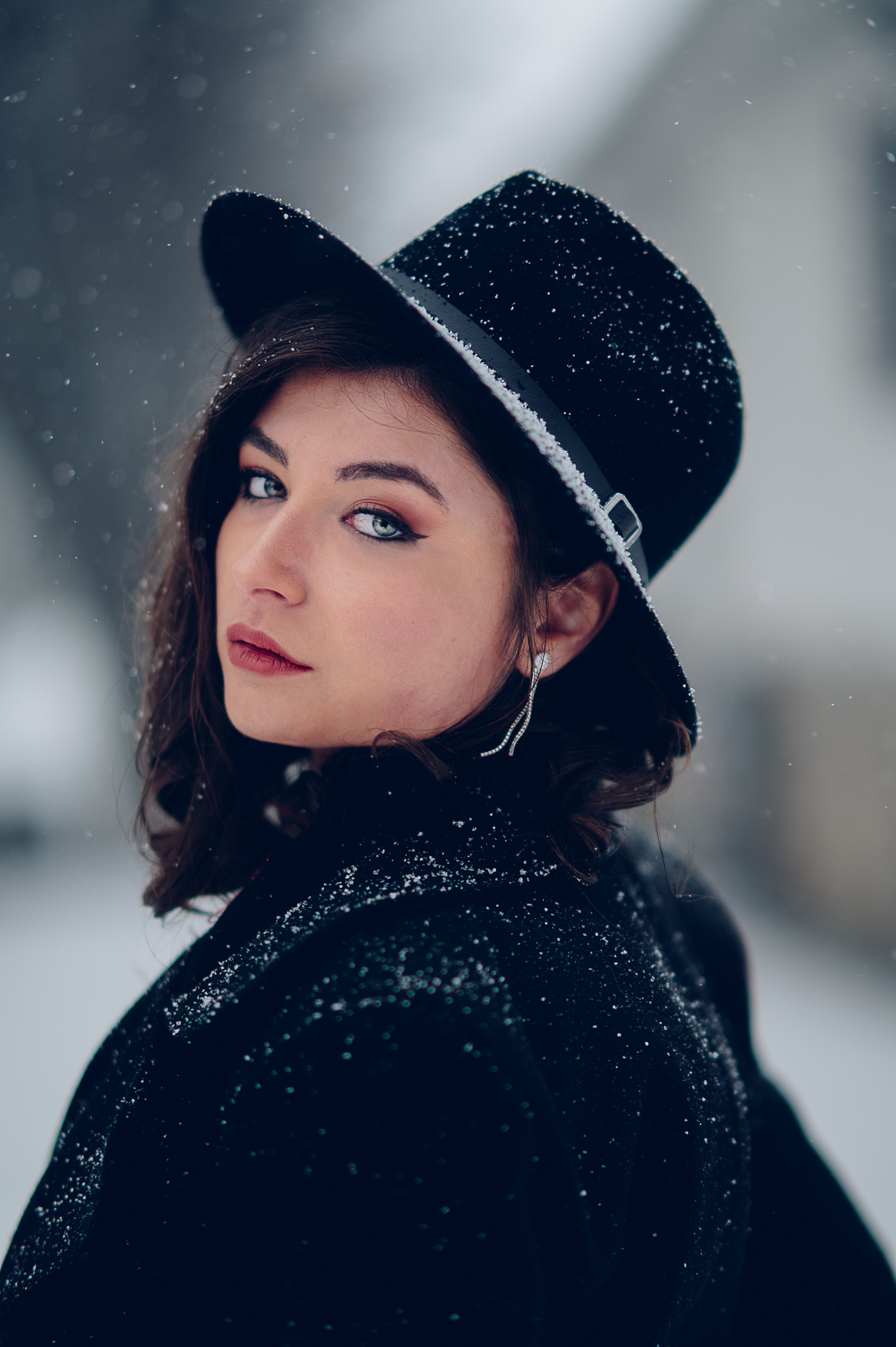 Posed Photo of a Young Woman in a Black Hat Covered in Snow · Free ...