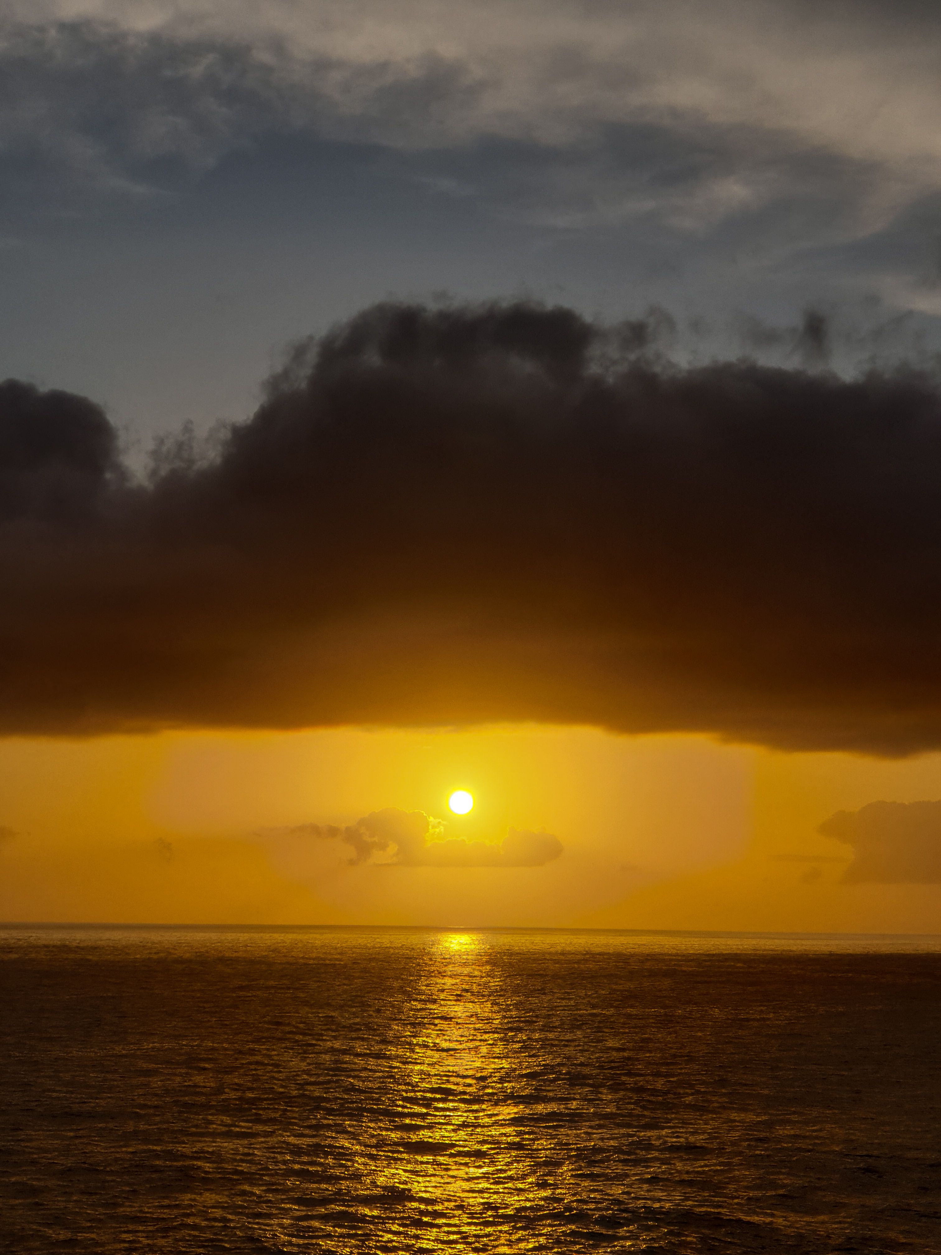 Rain Cloud and Sunlight over Calm Sea at Sunset · Free Stock Photo