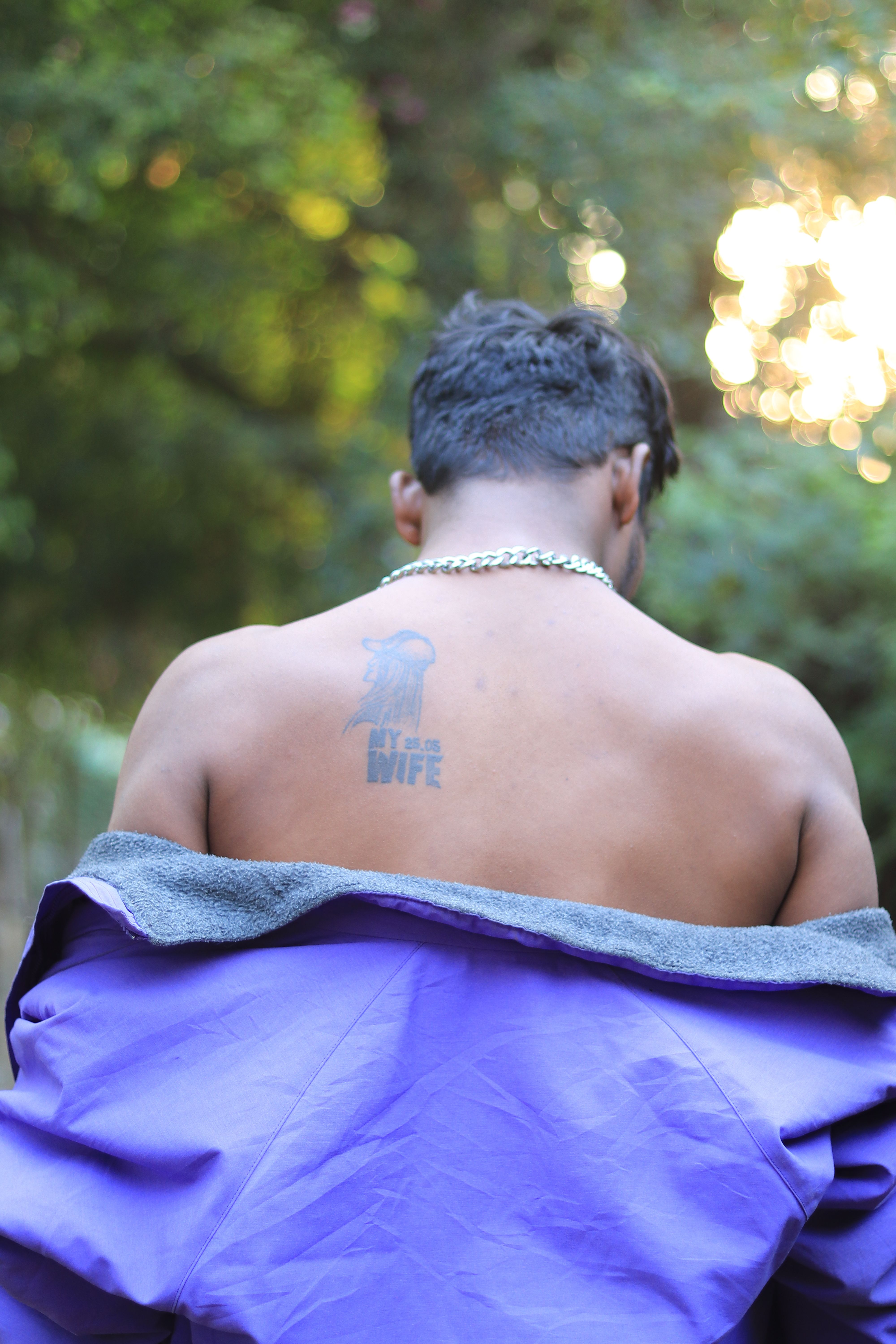 Back View of a Man Wearing Clothing with Zodiac Symbols, Standing under ...